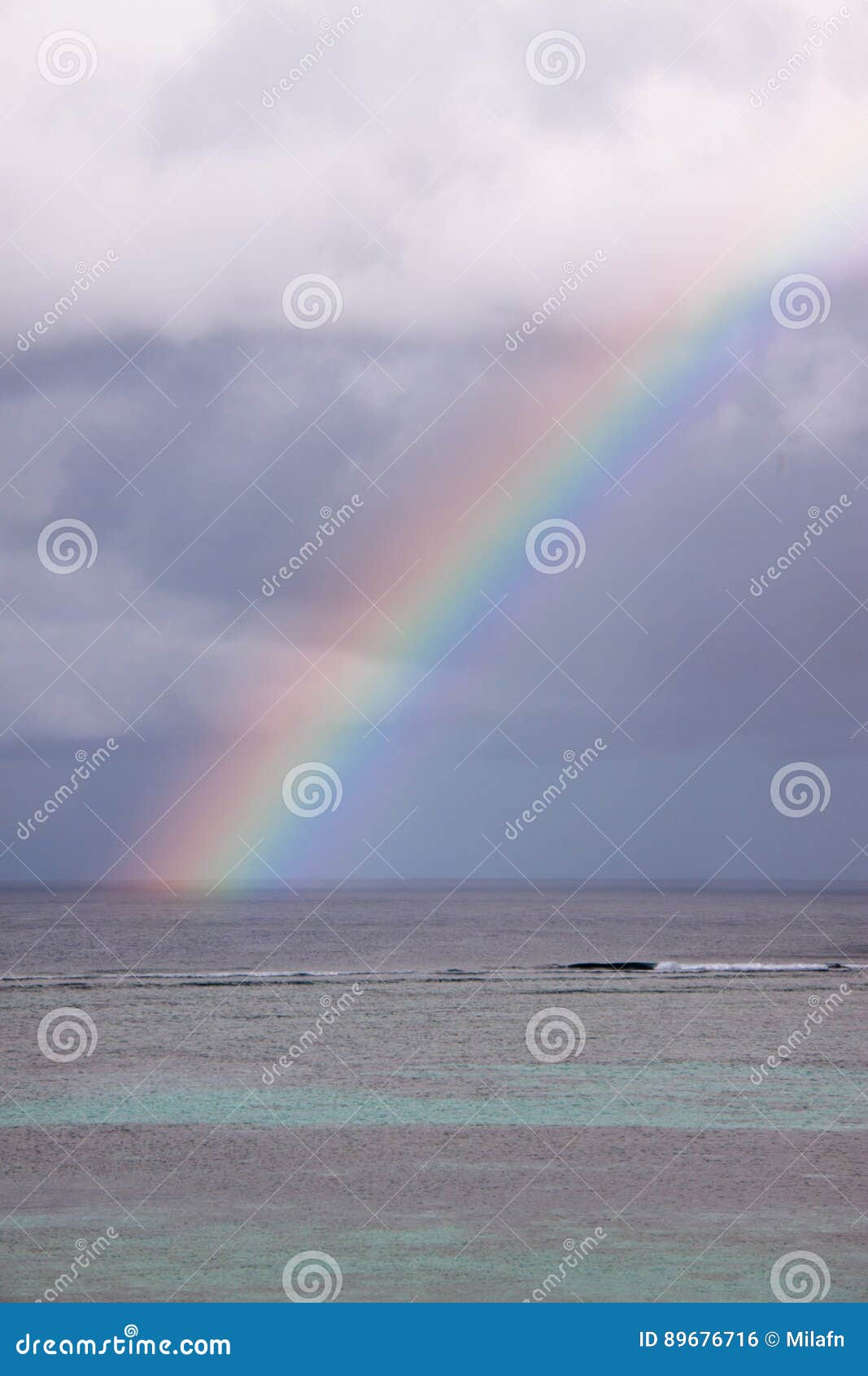 Rainbow over the sea. stock photo. Image of natural, phenomenon - 89676716