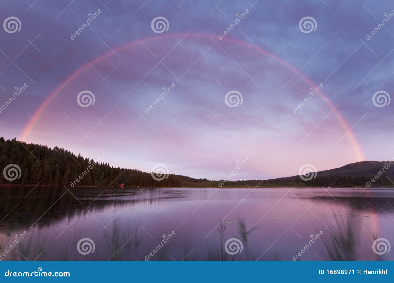 Rainbow over a small lake stock image. Image of colorful - 16898971