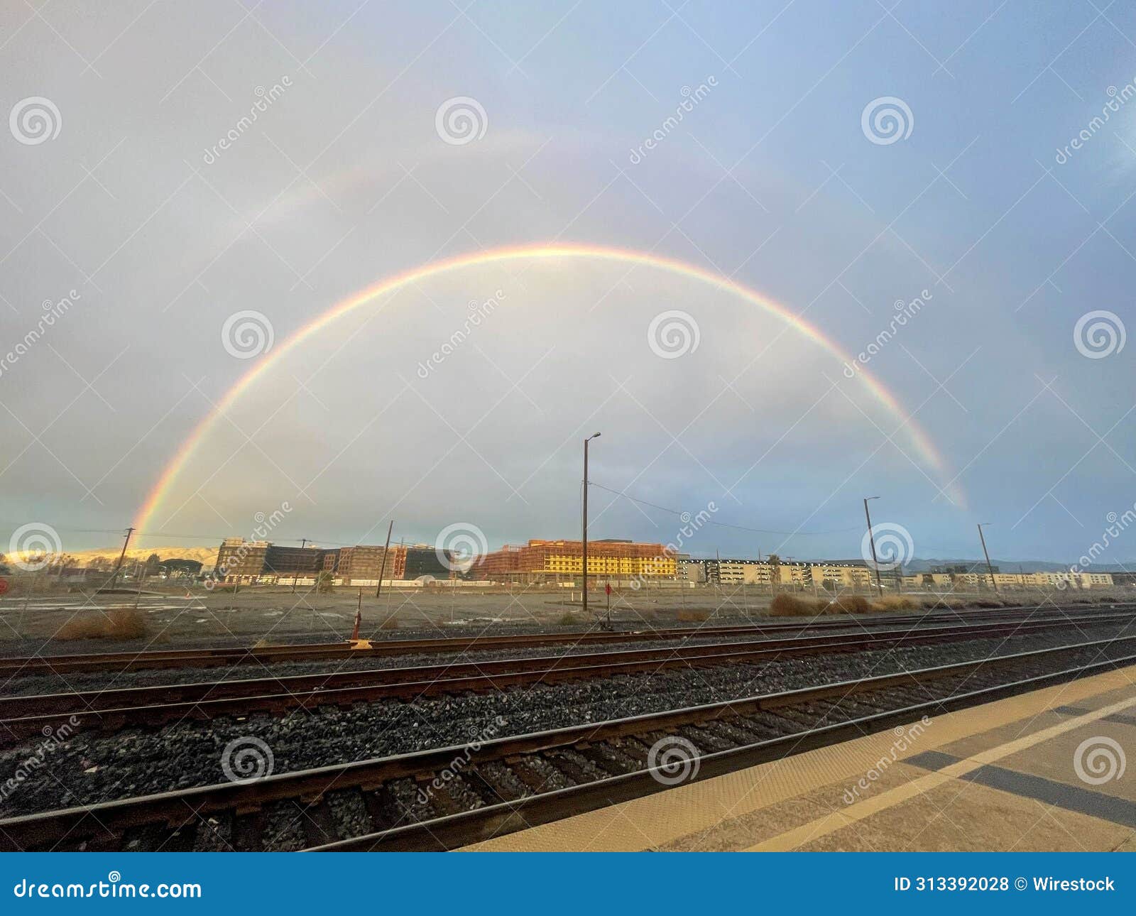 A Rainbow Appears To Be in the Middle of a Train Track Stock Photo ...