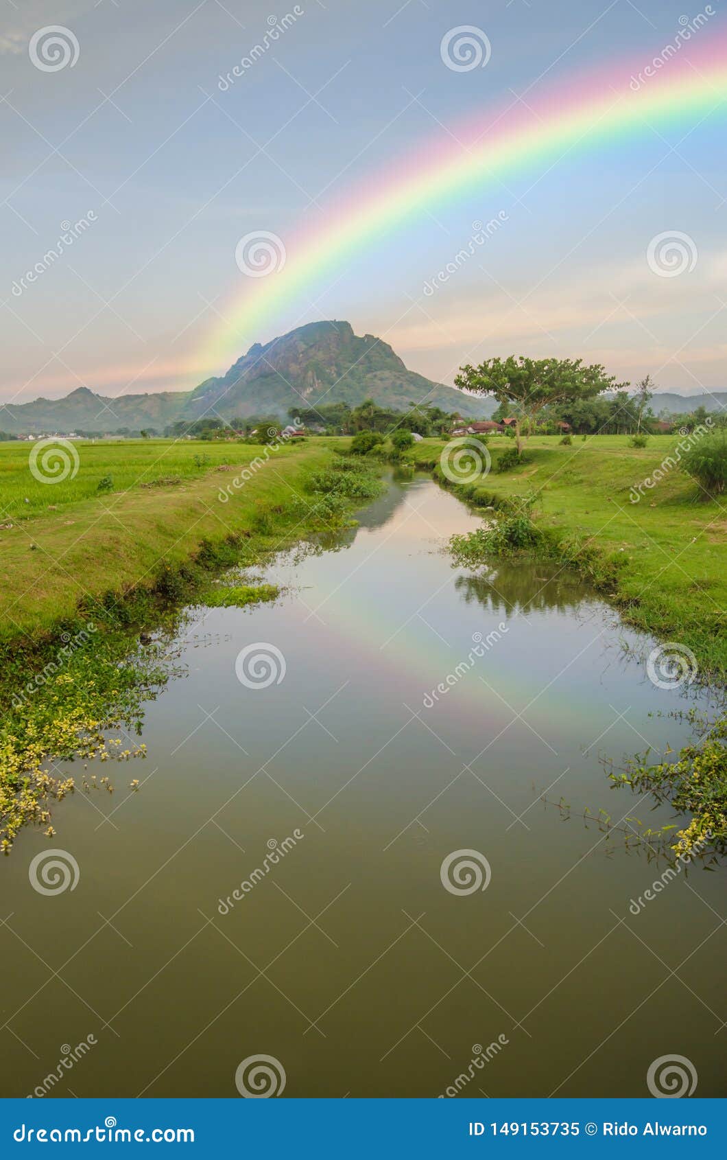 Rainbow and Reflection on the River. Mountain in the Distance Stock ...