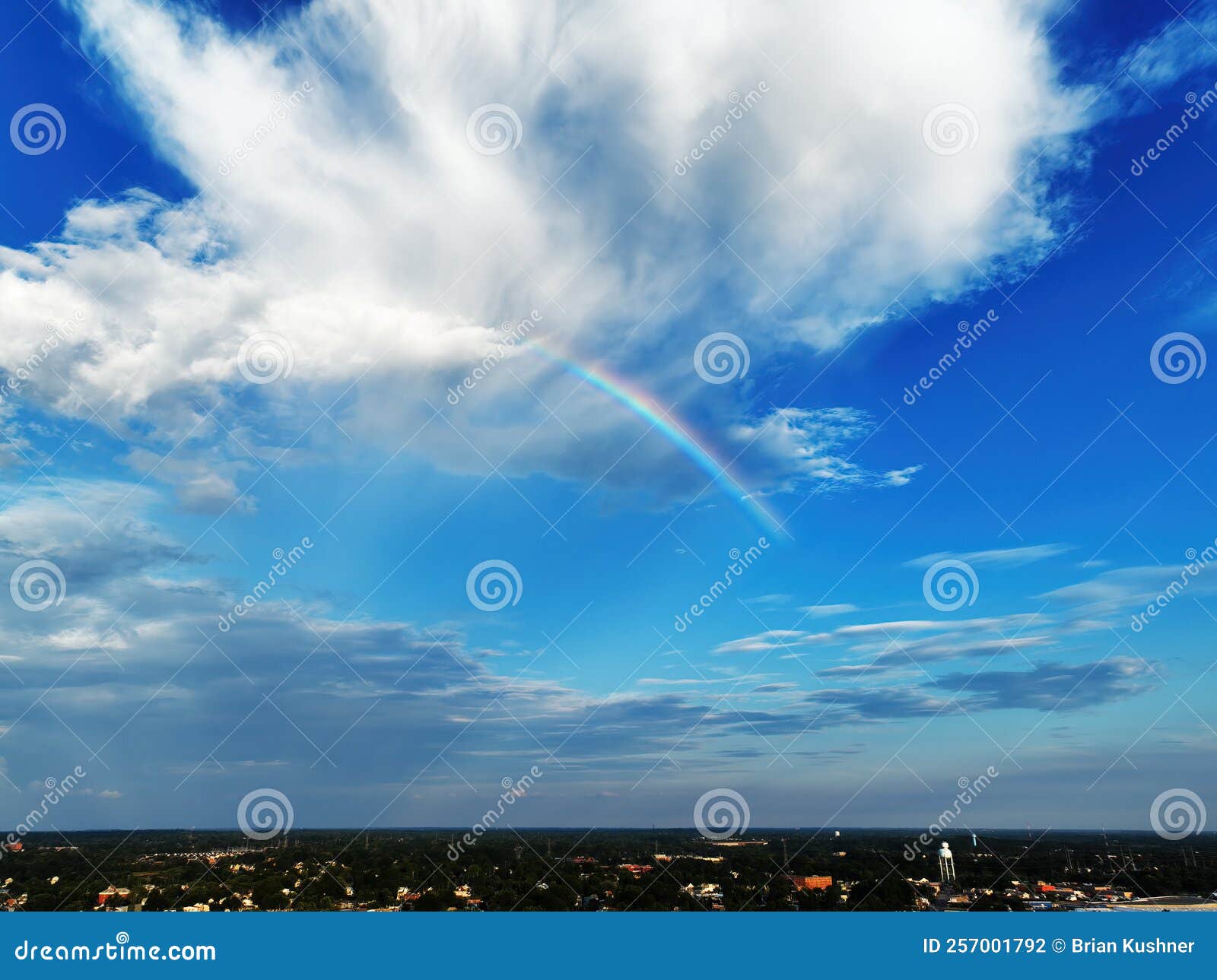 Rainbow Running through a Blue Sky Stock Photo - Image of landscape ...