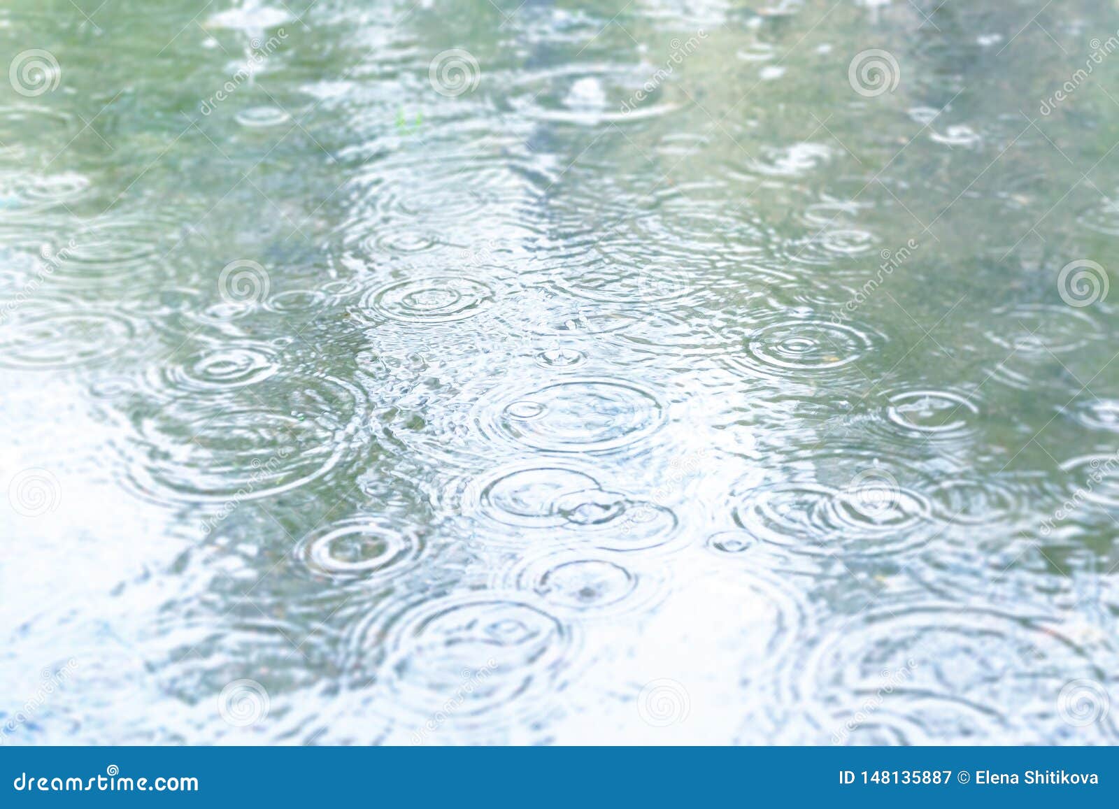 Raindrops Fall into a Puddle. Stock Image - Image of raindrops, water ...