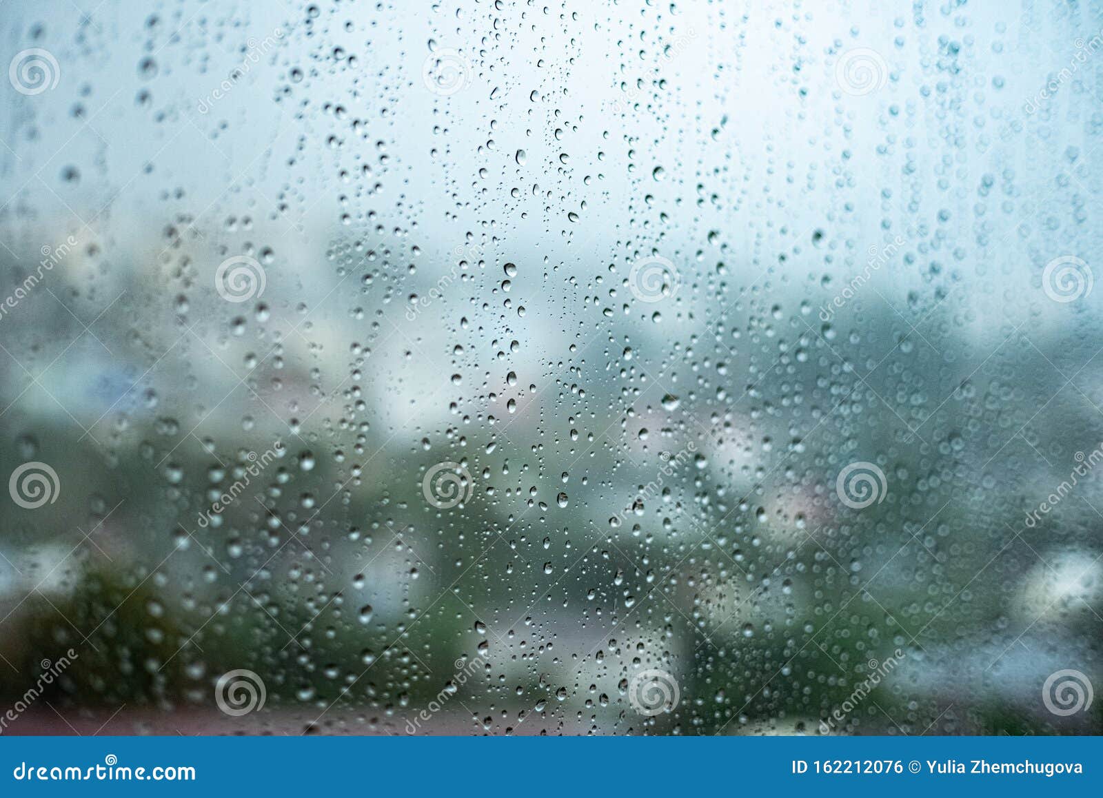 Raindrops on the Glass Outside the Window Cloudy Sky and Greenery Stock ...
