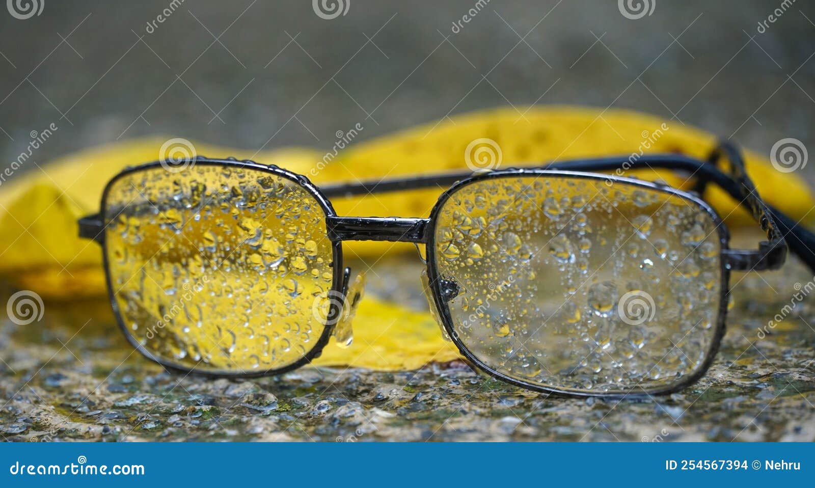Raindrops on Reading Glasses Placed on a Concrete Background. Stock ...