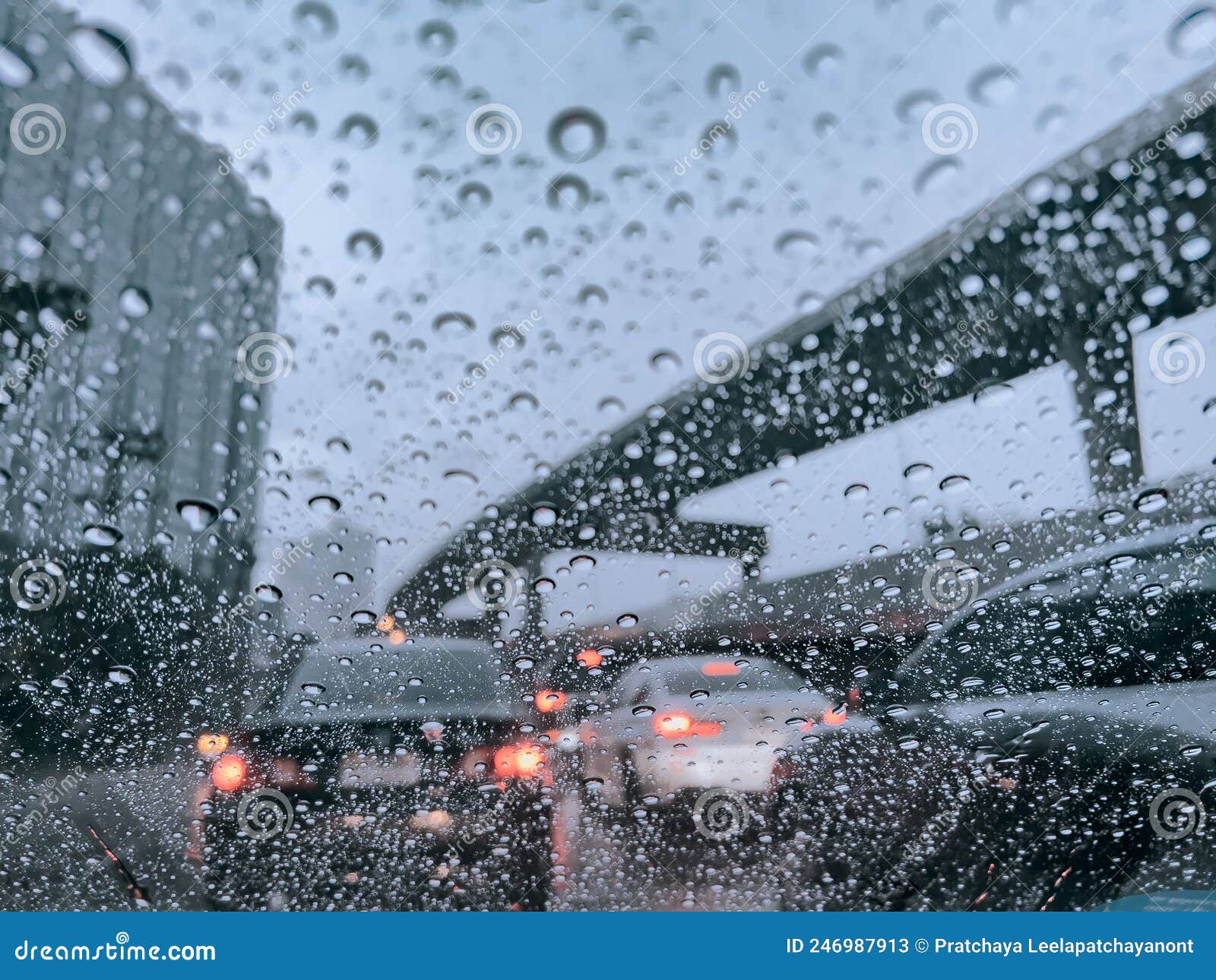 Raindrops Run Down on Car Windshield from Inside View. Traffic Jam ...