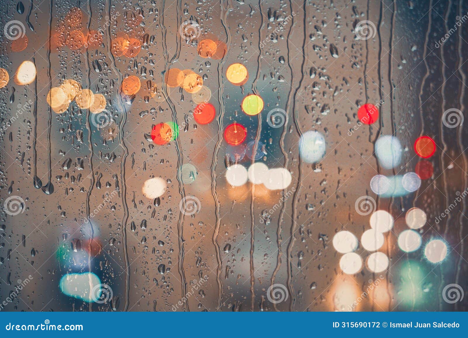 Raindrops on the Window and Multi Colored Street Lights at Night Stock ...