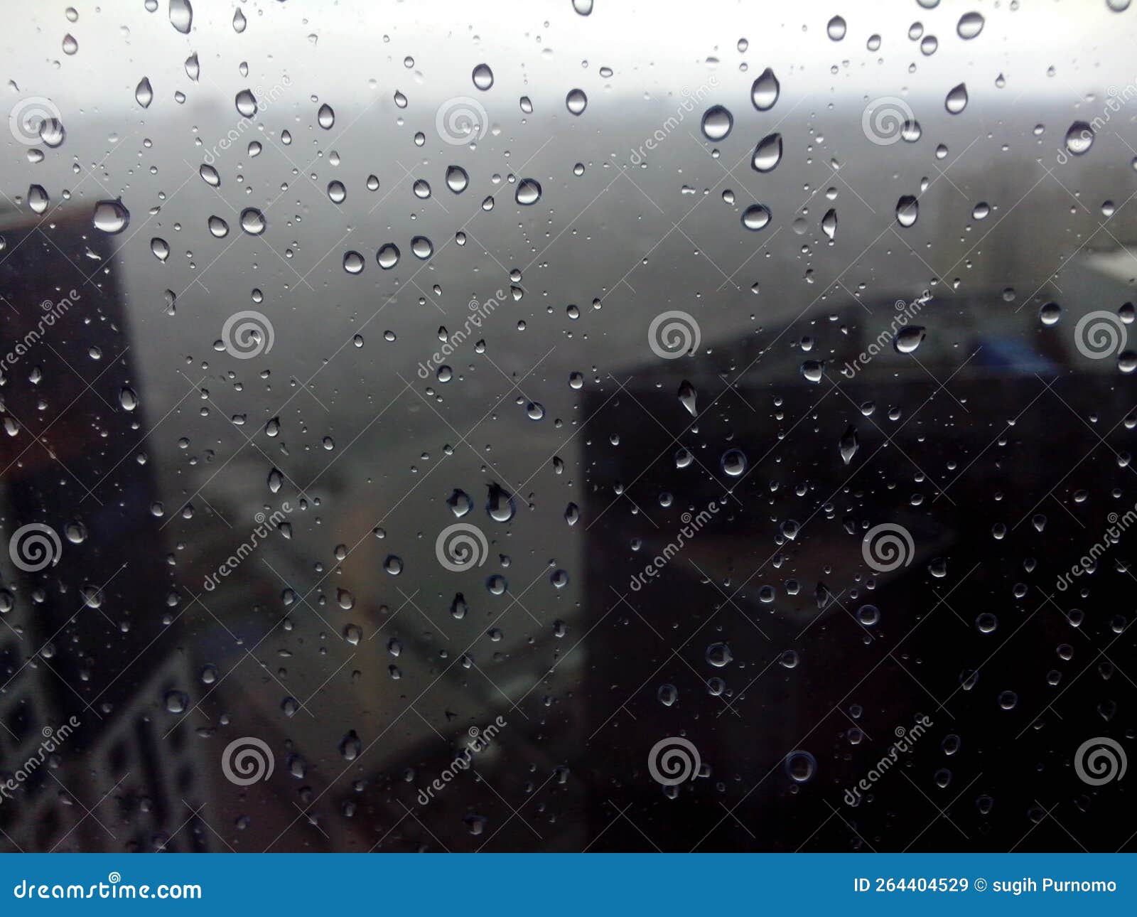 Raindrops Dripping on the Surface of a Window in a Building during ...