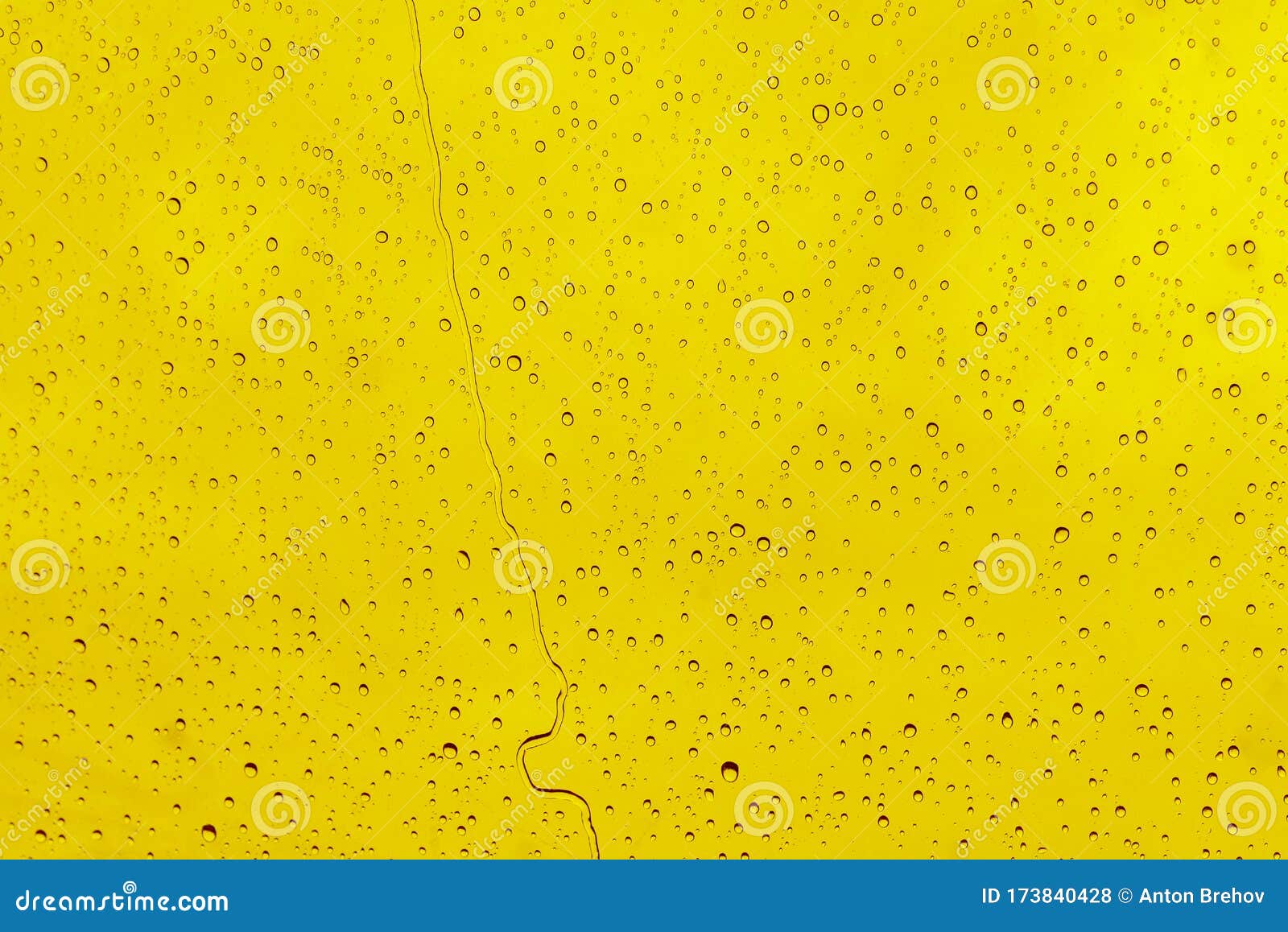 Raindrops on a Yellow Background. Flowing Water from the Surface of the ...