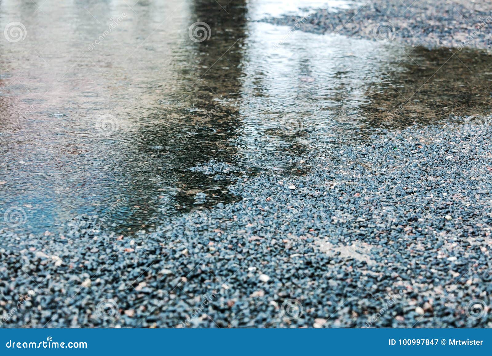 Rainwater Puddle on Pavement with Ripples and Sky Reflection Stock ...
