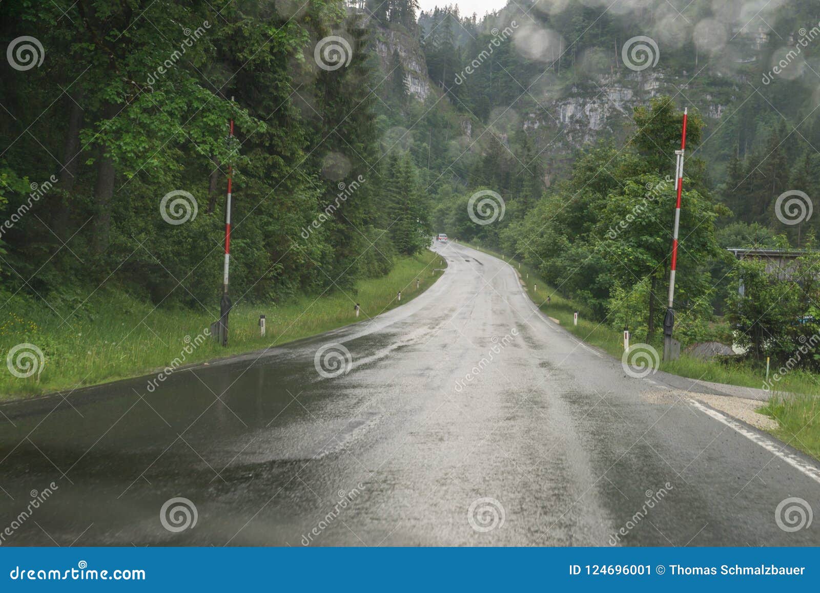 Rainy Road Surface and Raindrops on a Car Windshield Stock Image ...