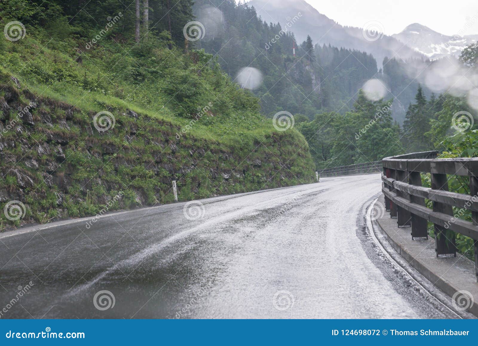 Rainy Road Surface and Raindrops on a Car Windshield Stock Photo ...