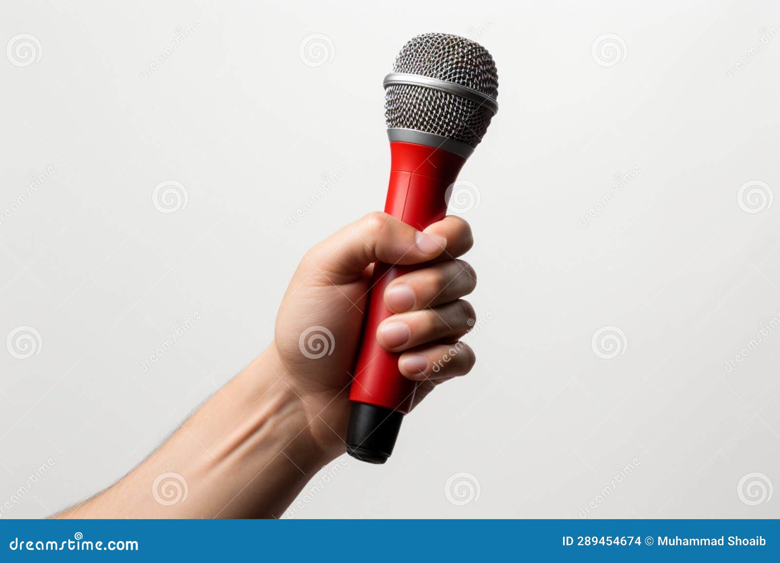 A Raised Hand Clutches a Microphone, Set Against an Isolated White ...