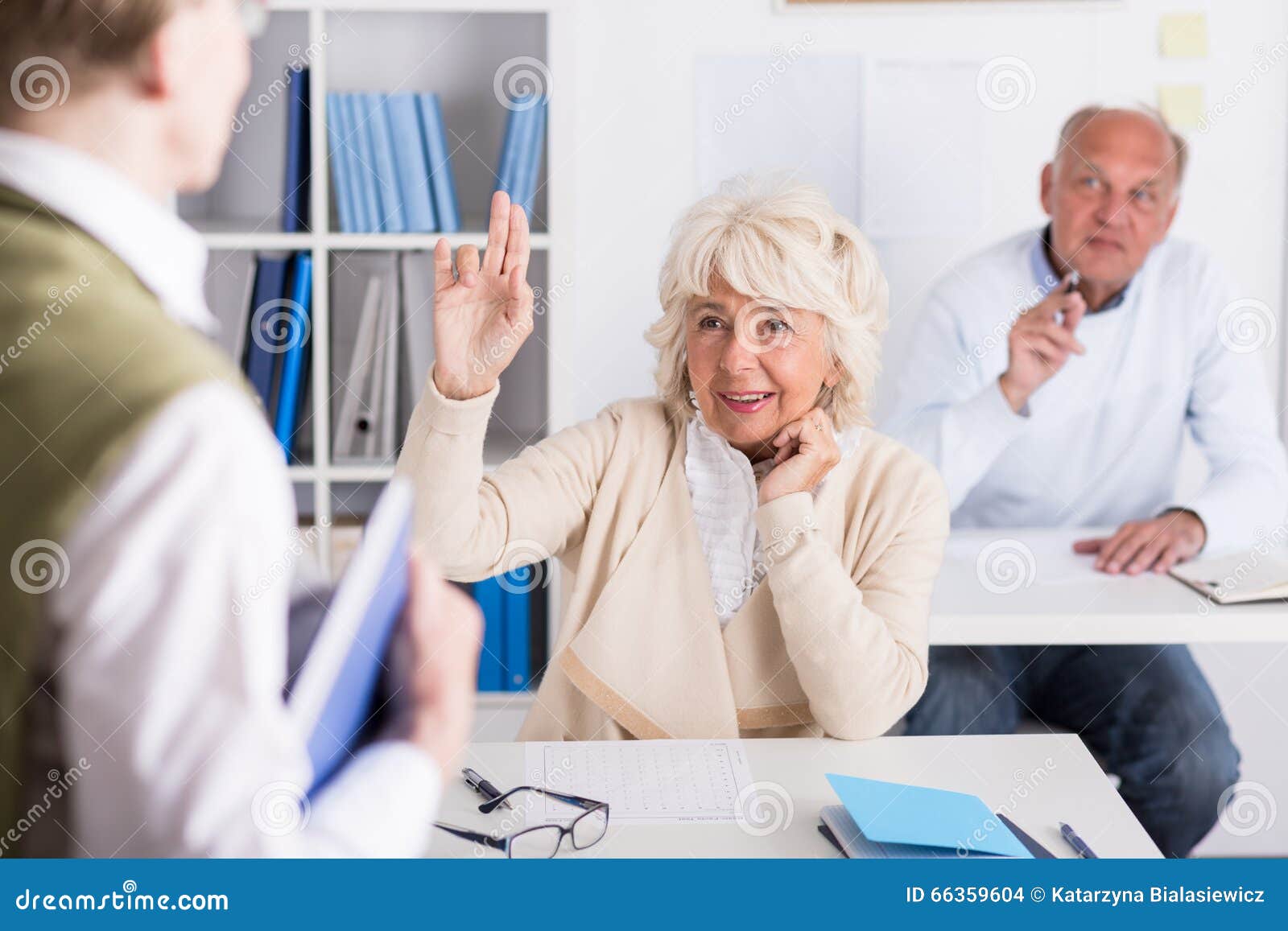 Raising hand to answer stock photo. Image of elderly - 66359604