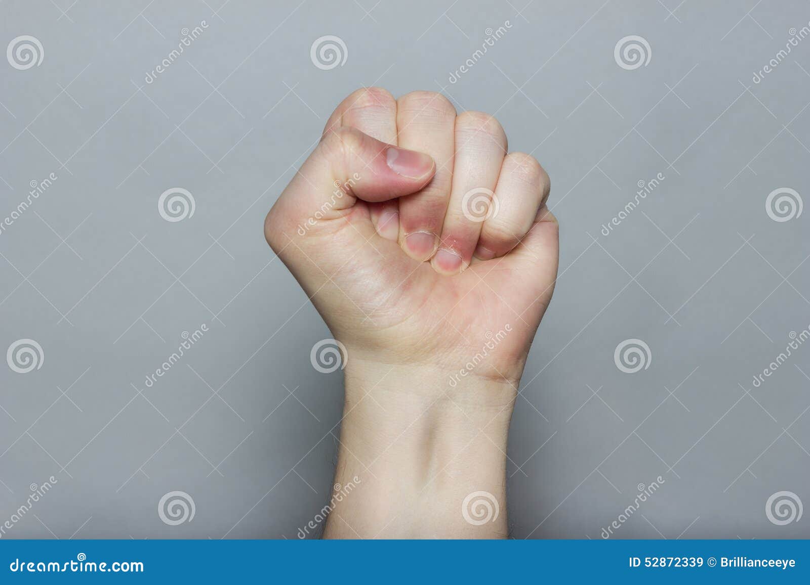 Raising Up Left Fist in Front of Grey Background Stock Image - Image of ...