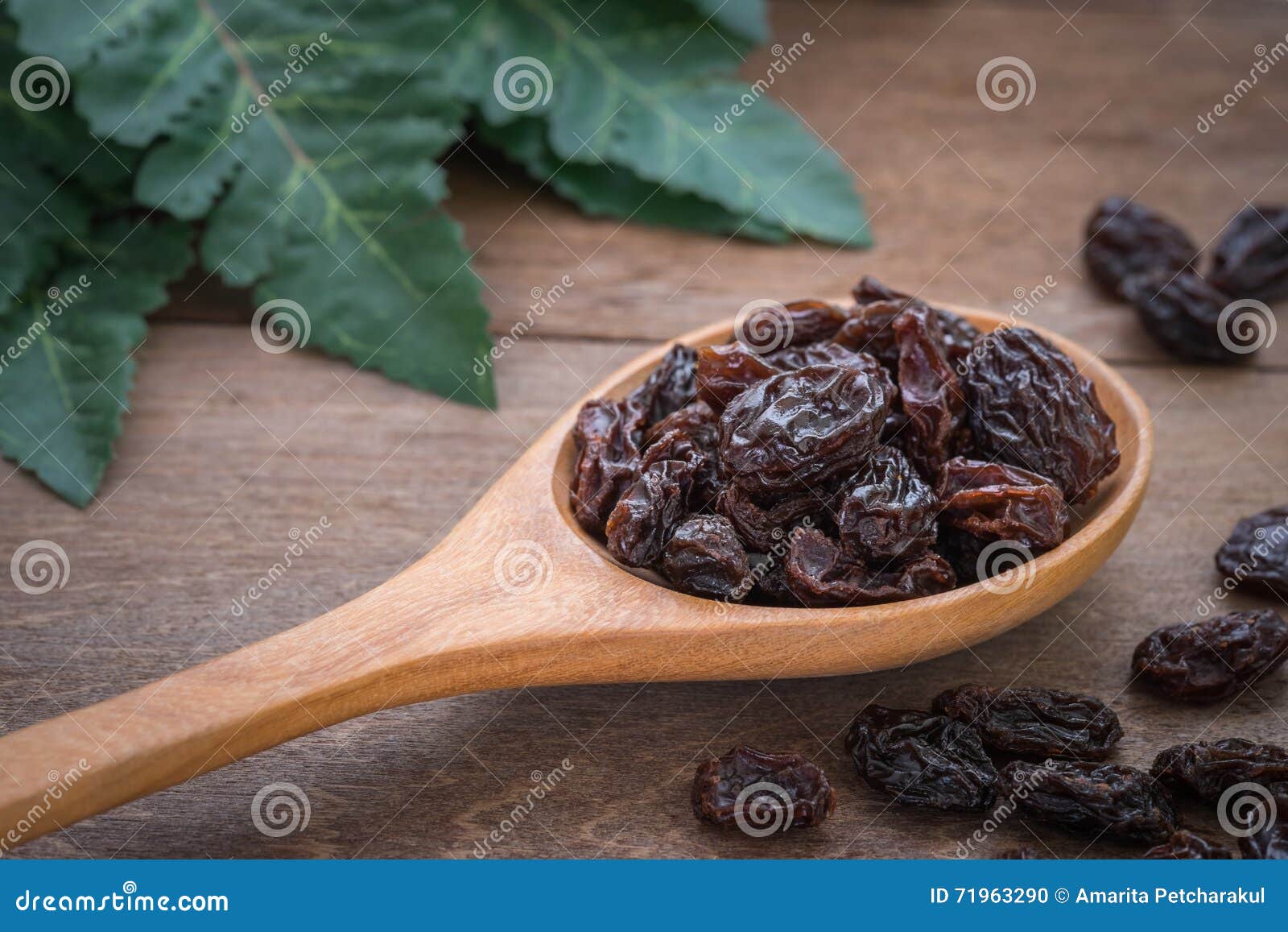 Raisins on wooden spoon stock photo. Image of healthy - 71963290