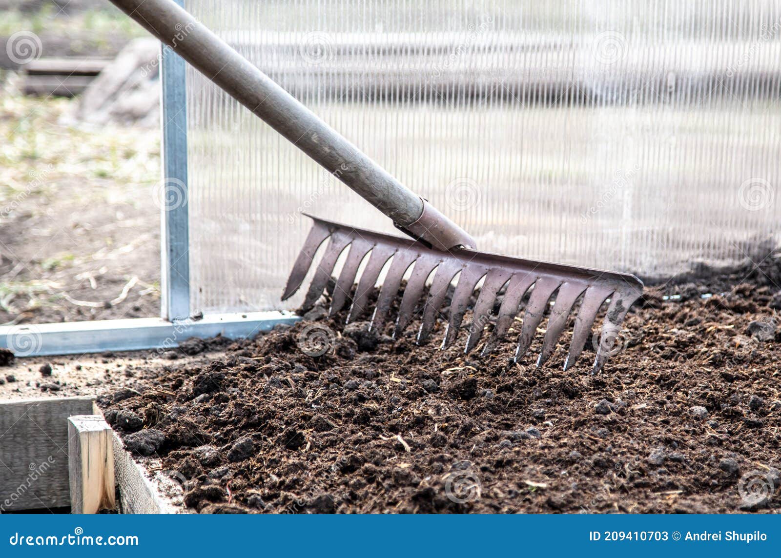 The rake is on the ground stock image. Image of garden - 209410703