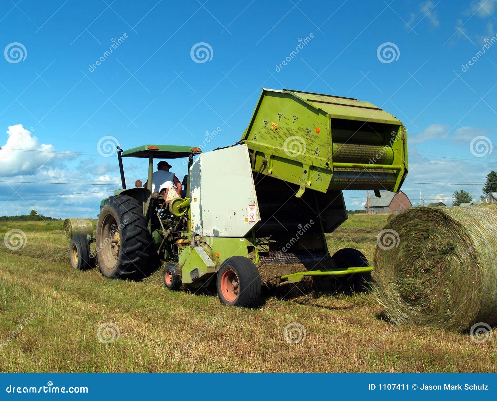 Raking Rolls of Hay stock image. Image of farm, blue, working - 1107411