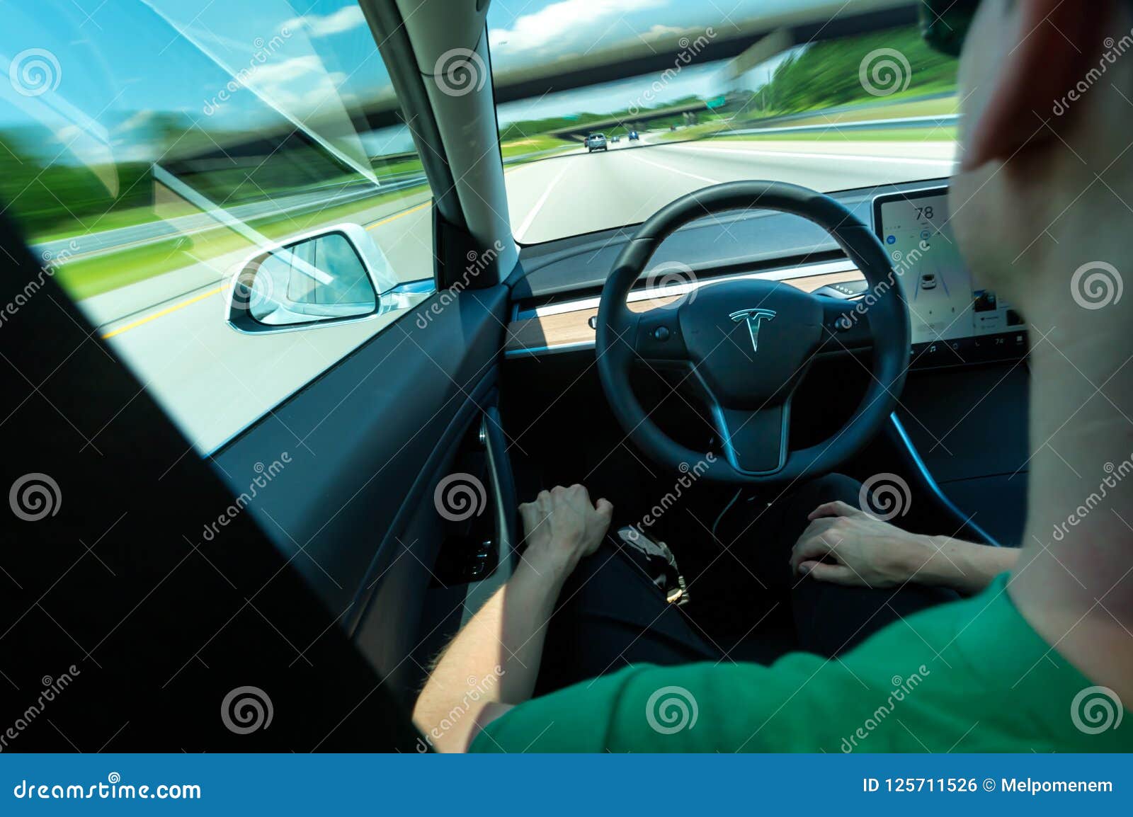 Person Using the Self-driving Function in an All Electric Tesla Model 3 ...