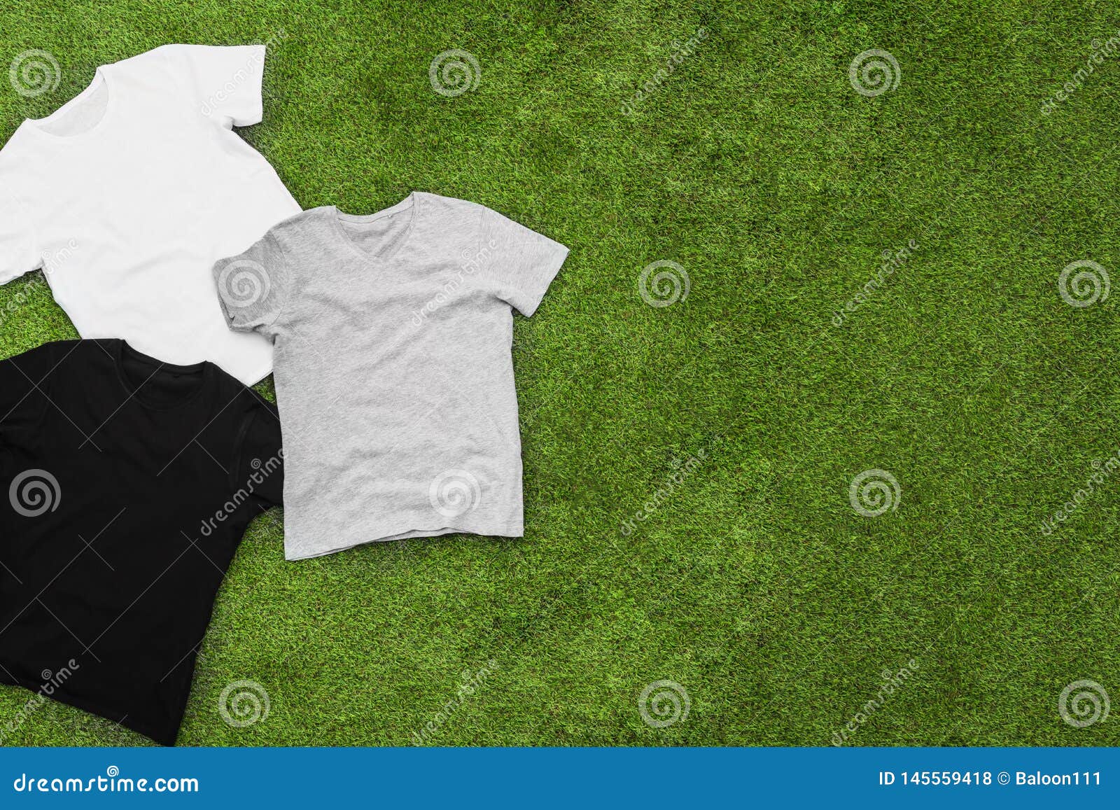 Randomly Scattered Mens Different Coloured T-shirts on Grass Background ...