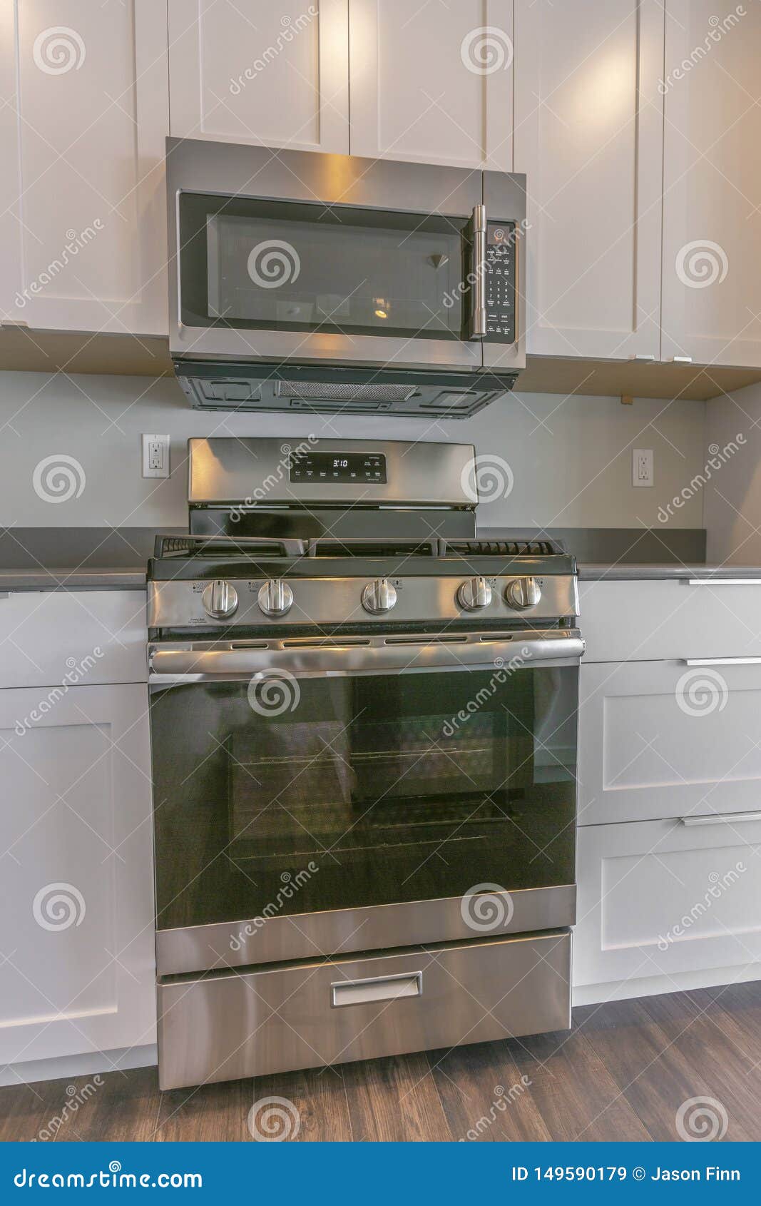 Range and Wall Mounted Microwave Inside the Modern Kitchen of a New ...
