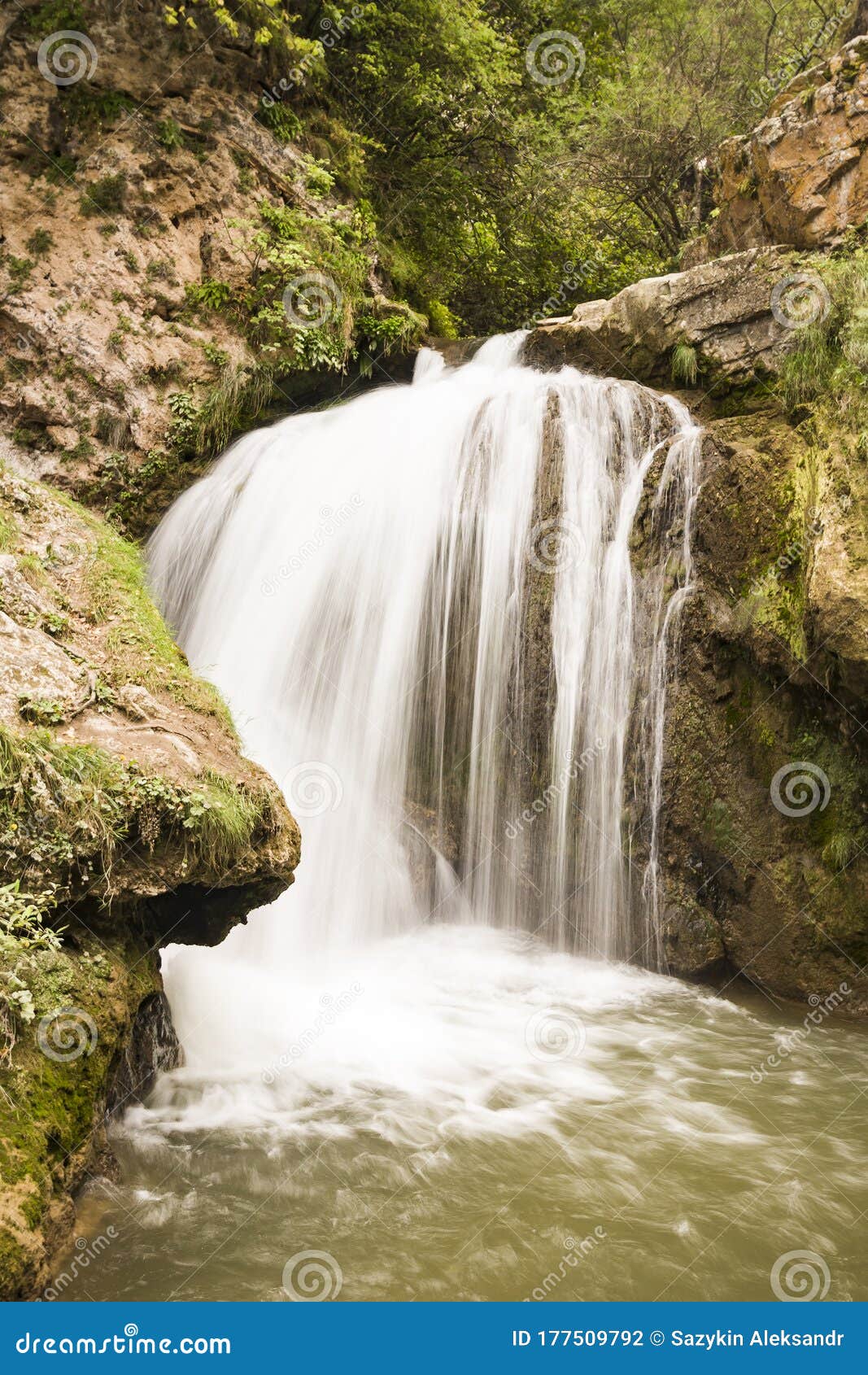 A Rapid Mountain Stream of Water Forms a Large Waterfall. the Stream of ...