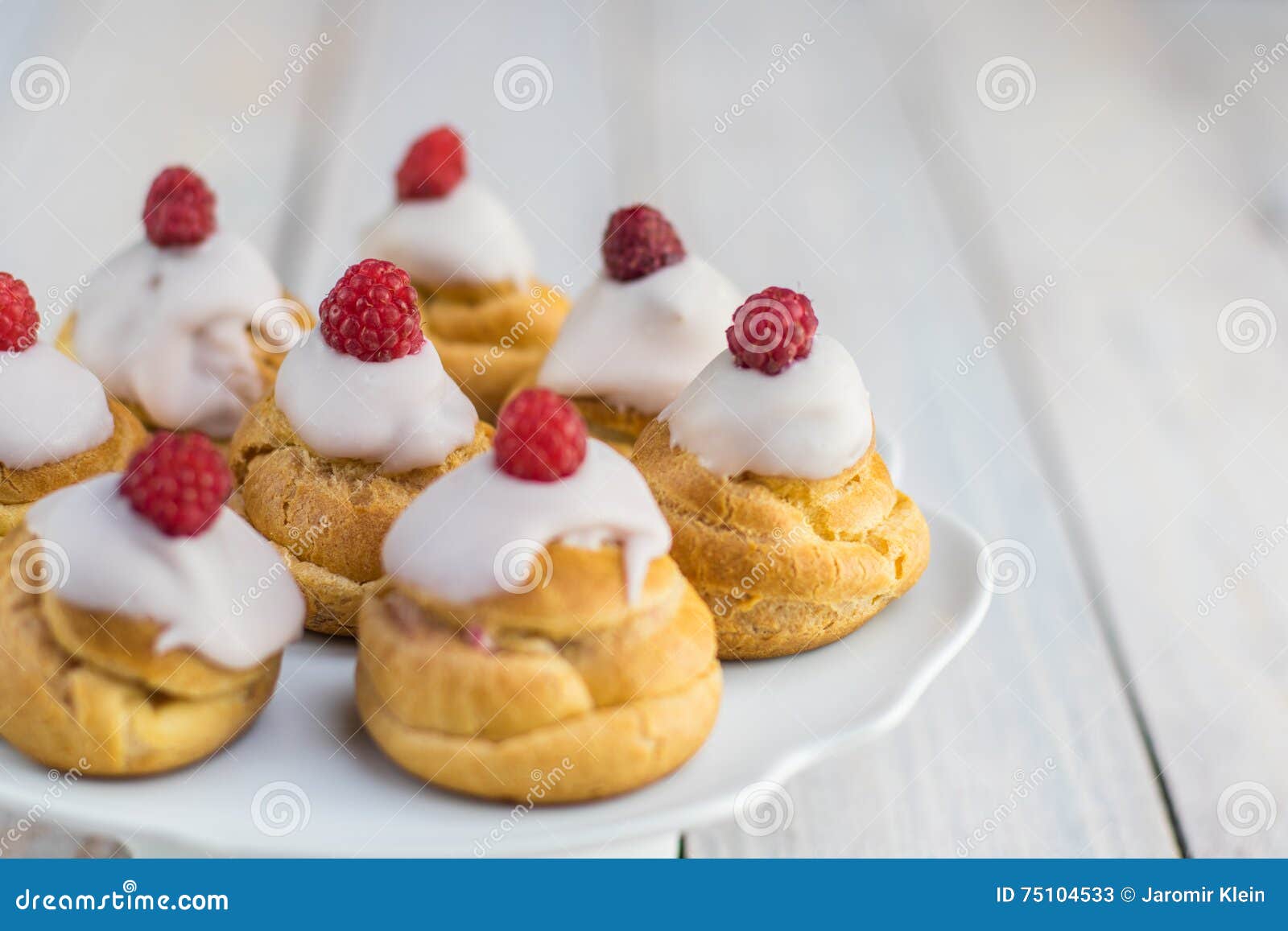 Raspberries Profiteroles with White Chocolate on White Plate Stock ...