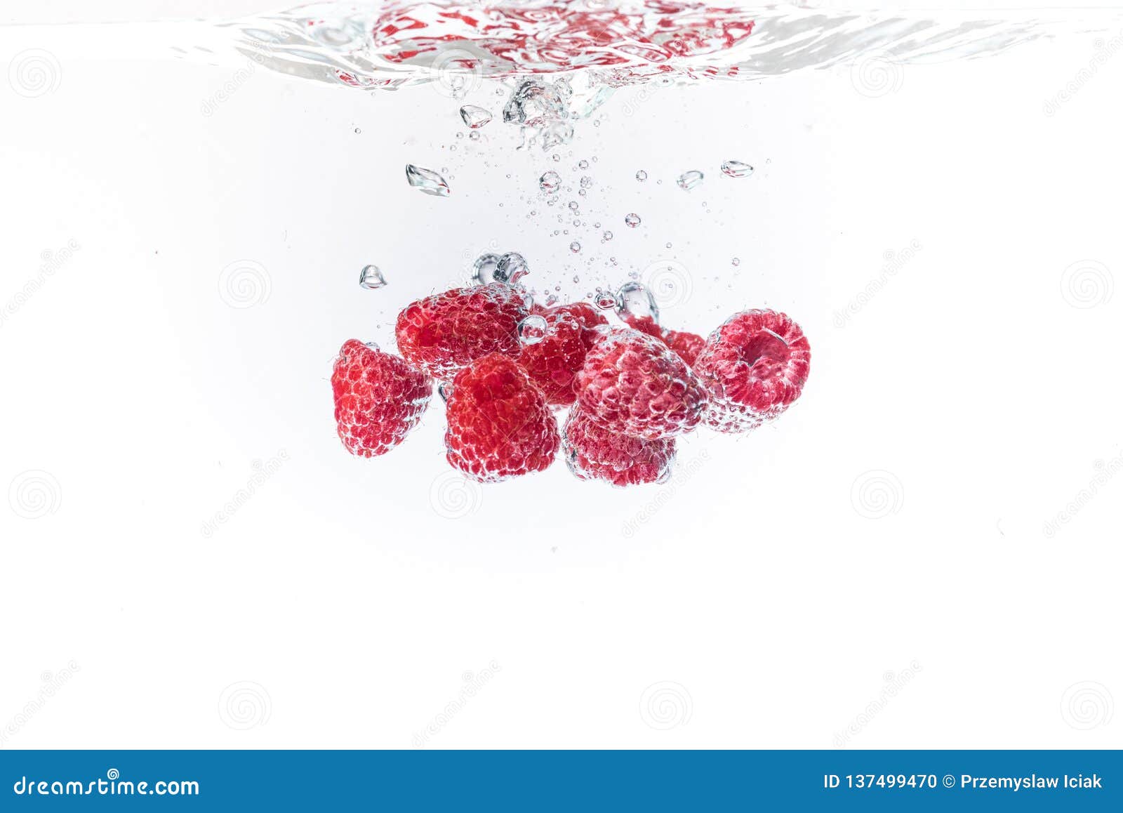Raspberries Splashing into Crystal Clear Water with Air Bubbles Stock ...