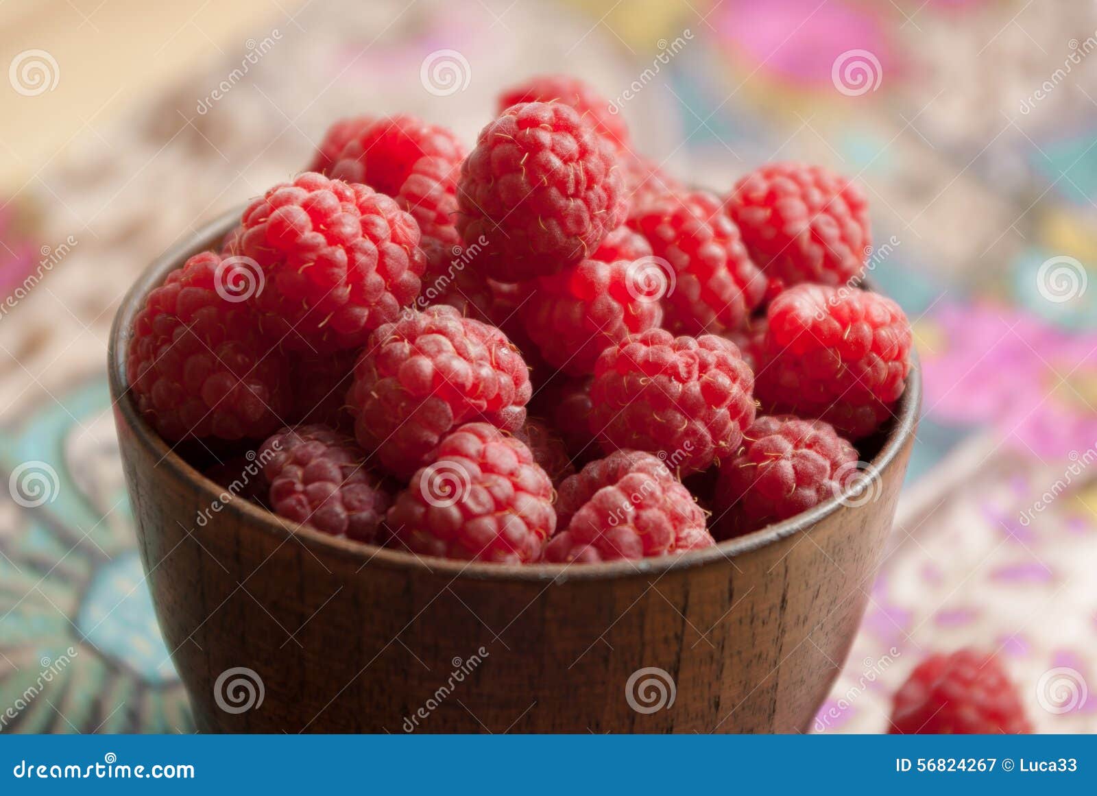 Raspberries in wooden bowl stock image. Image of table - 56824267