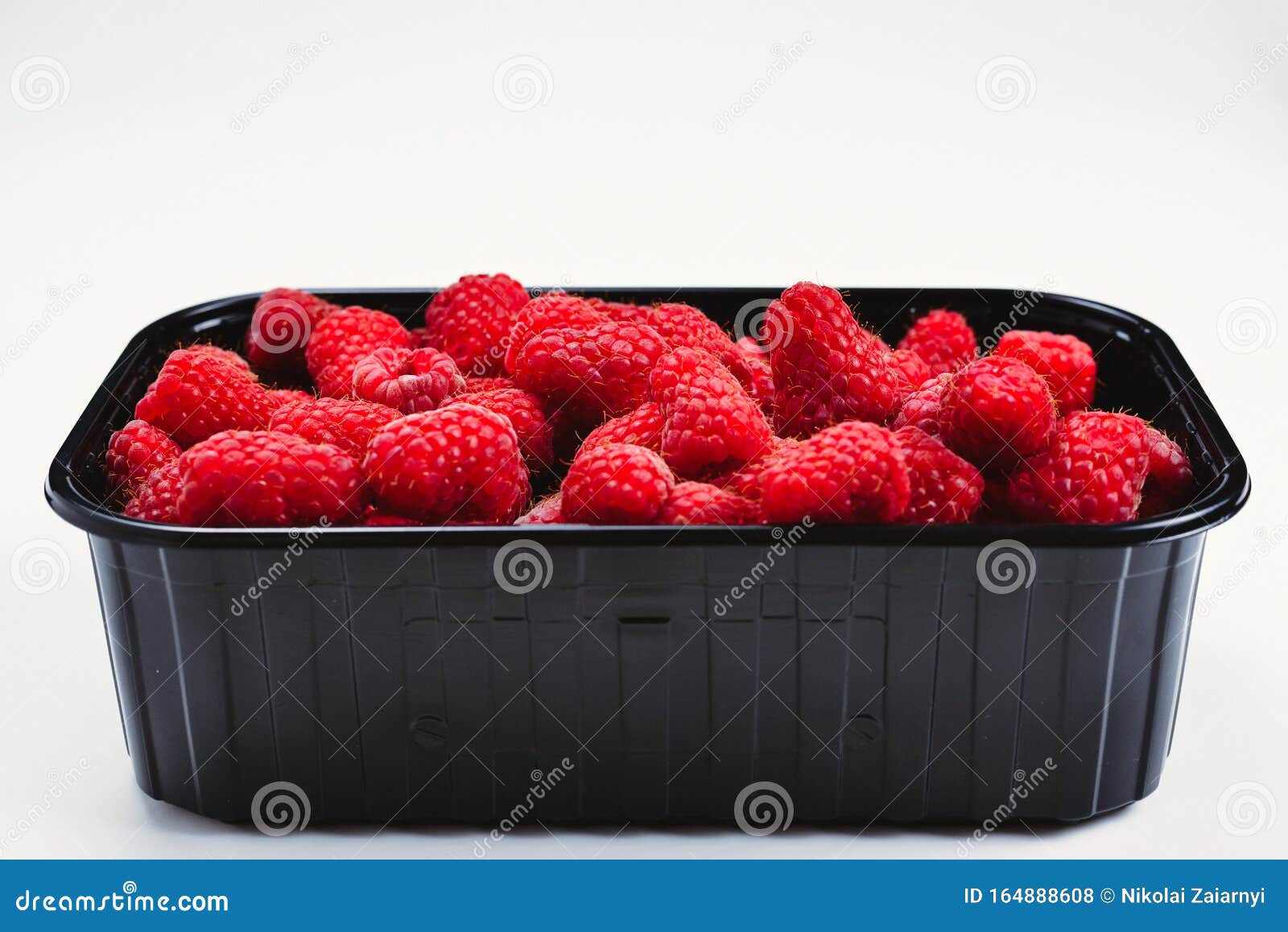 Raspberry in Black Container Isolated on White Background Stock Photo ...