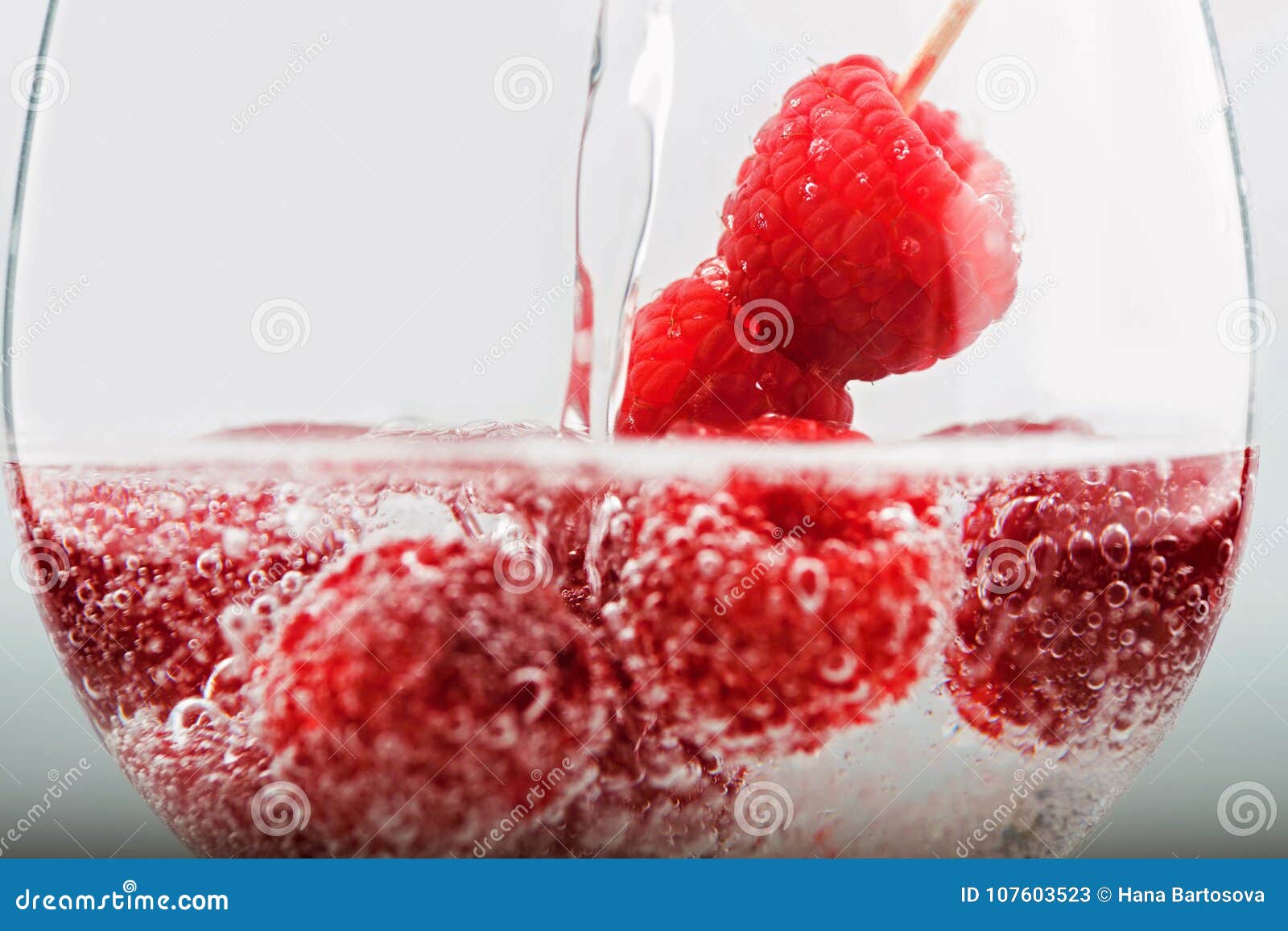 Raspberry with Bubbles in Glass with Pouring Water. Stock Image - Image ...