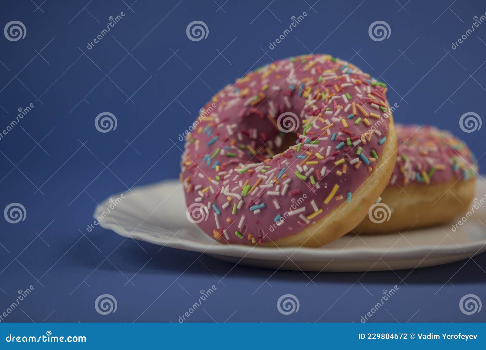 Raspberry Donuts on a Dark Blue Background Stock Photo - Image of ...