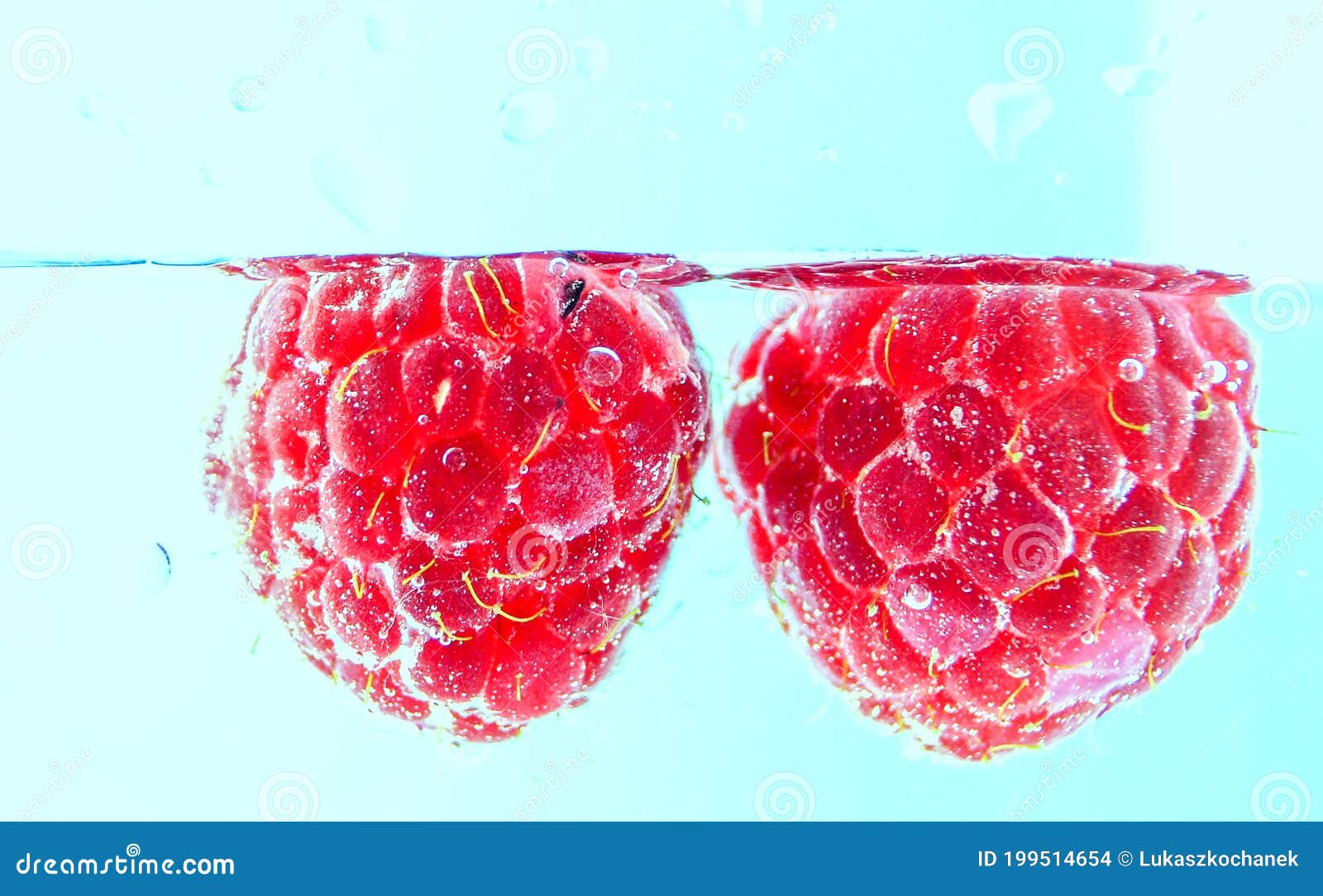 Raspberry Dropped into Water Splash on Blue Stock Photo - Image of ...