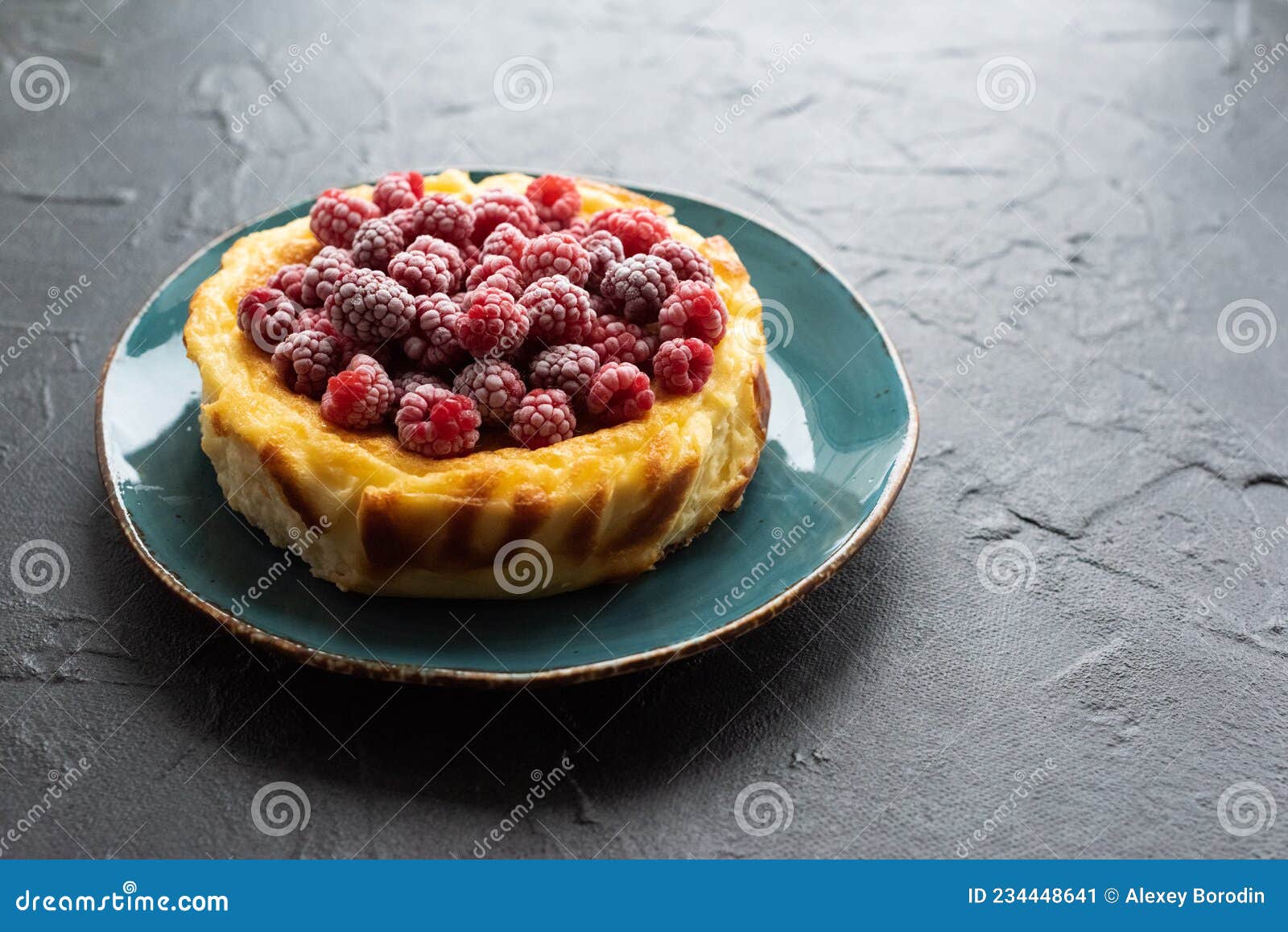 Raspberry Homemade Cheesecake on Blue Plate with Dark Plaster ...
