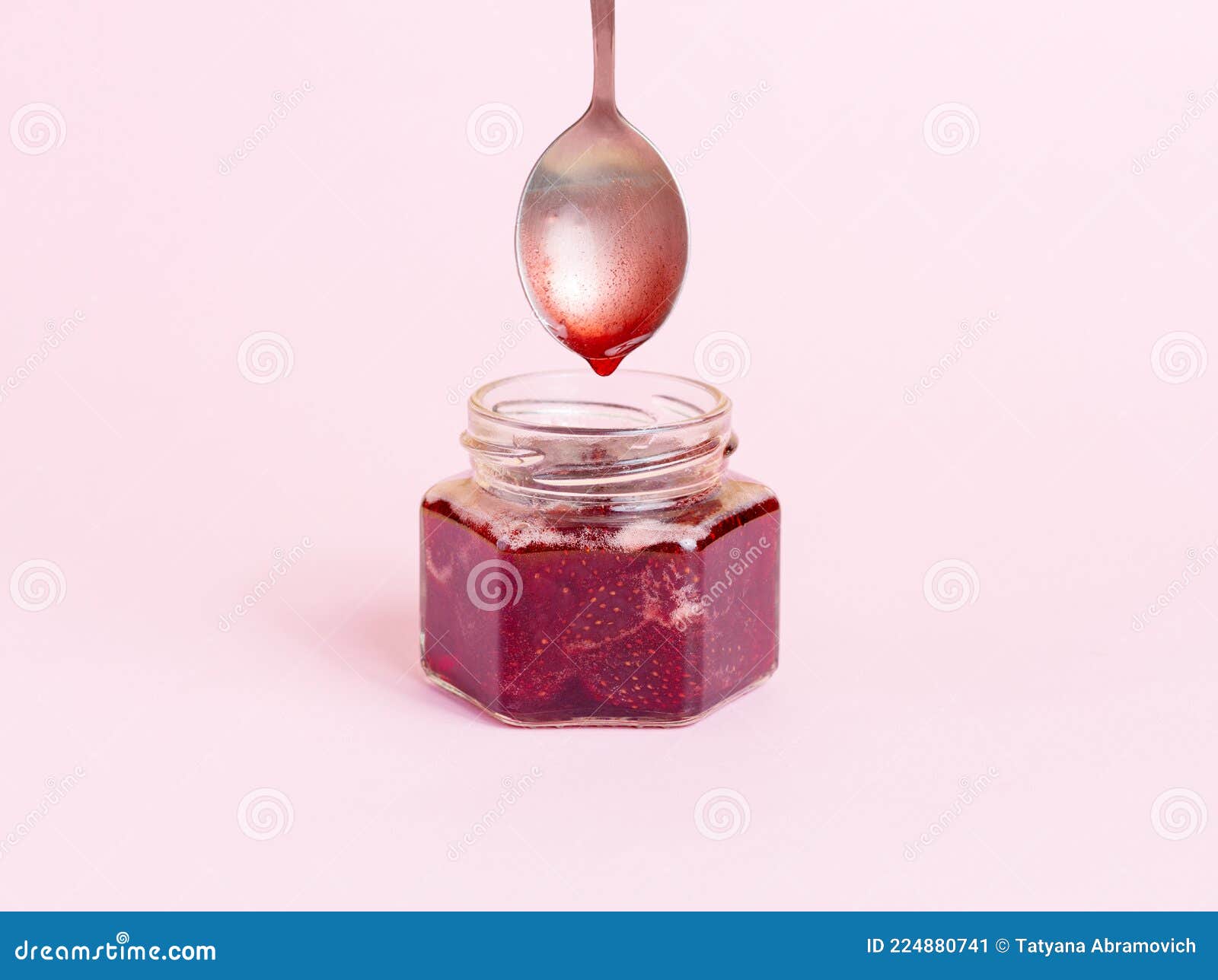 Raspberry Jam Dripping from a Spoon into a Small Glass Jar. Stock Image ...