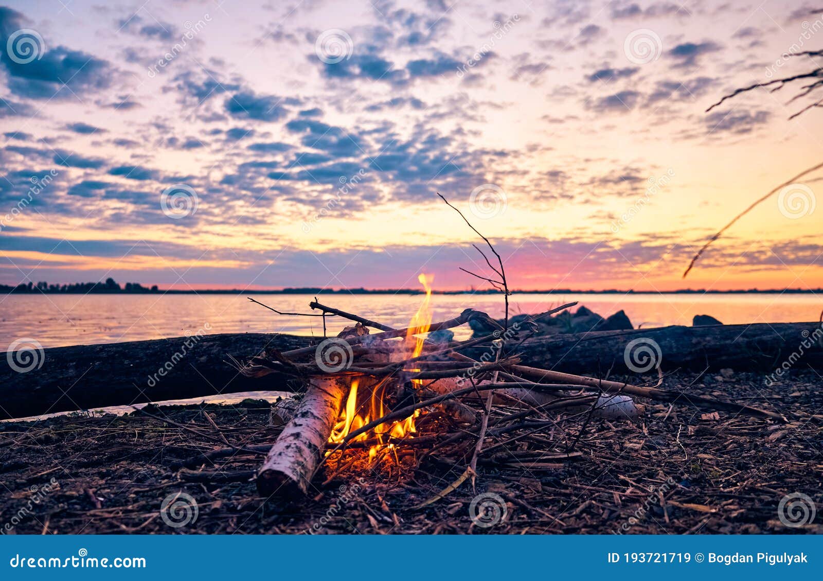 Raspberry Sunset on the Shore. Campfire by the River Stock Image ...