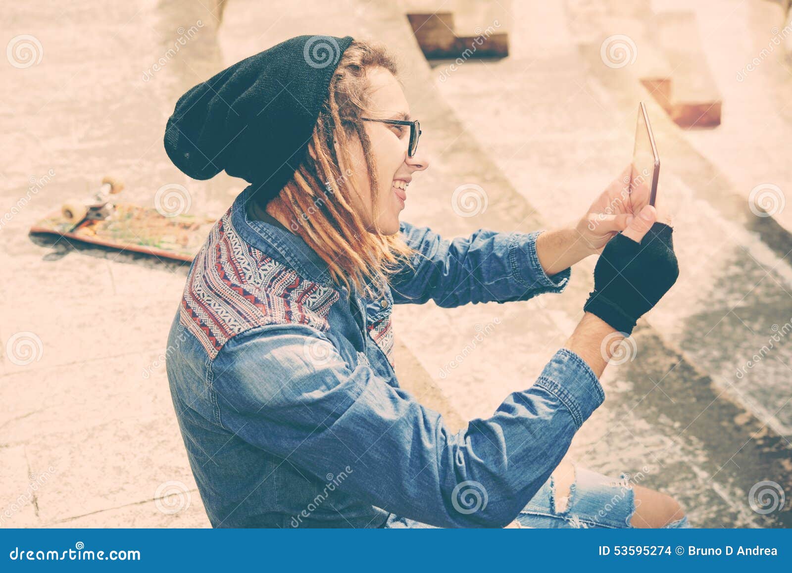 Rasta Guy Taking Selfie Sitting on a Staircase with Tablet Warm Stock ...