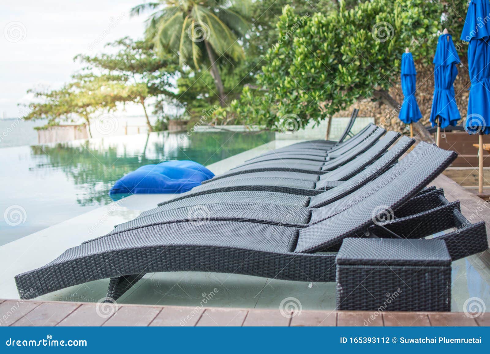 Rattan Daybed beside Swimming Pool Stock Photo - Image of lifestyle ...