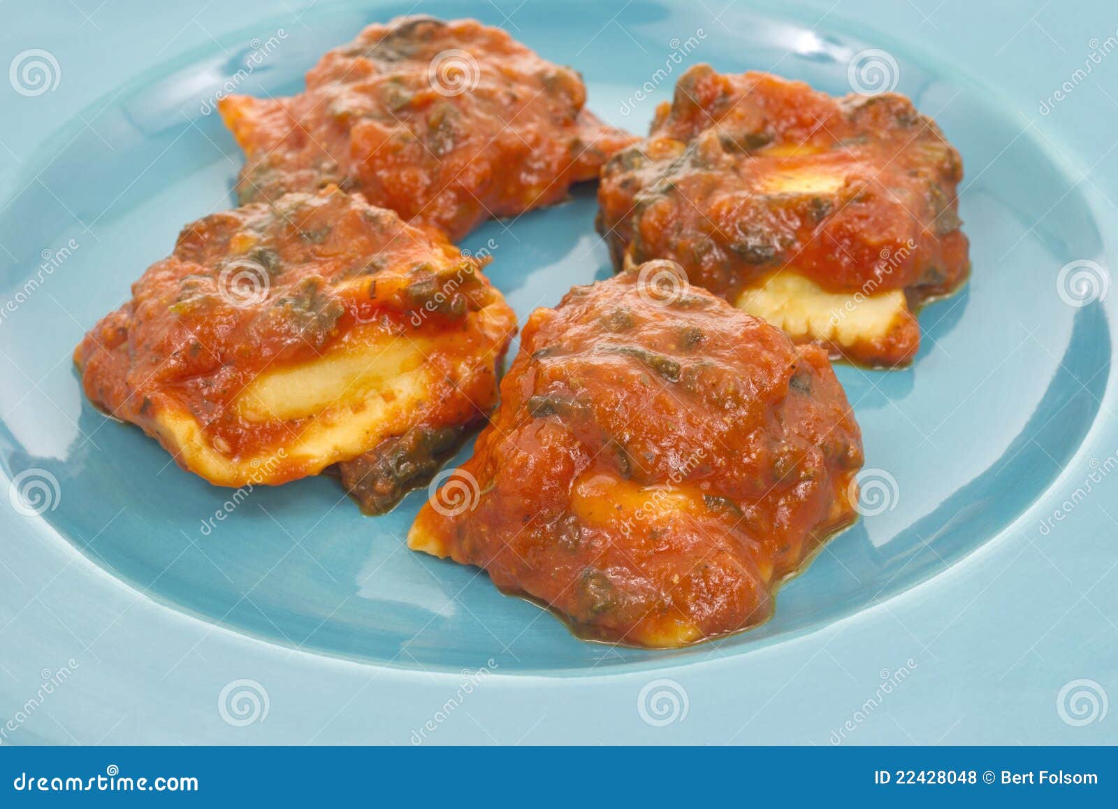 Ravioli on blue plate stock photo. Image of close, blue - 22428048