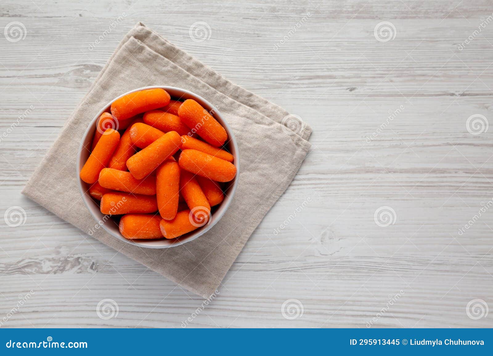Raw Baby Carrots in a Bowl on a White Background, Top View. Copy Space ...