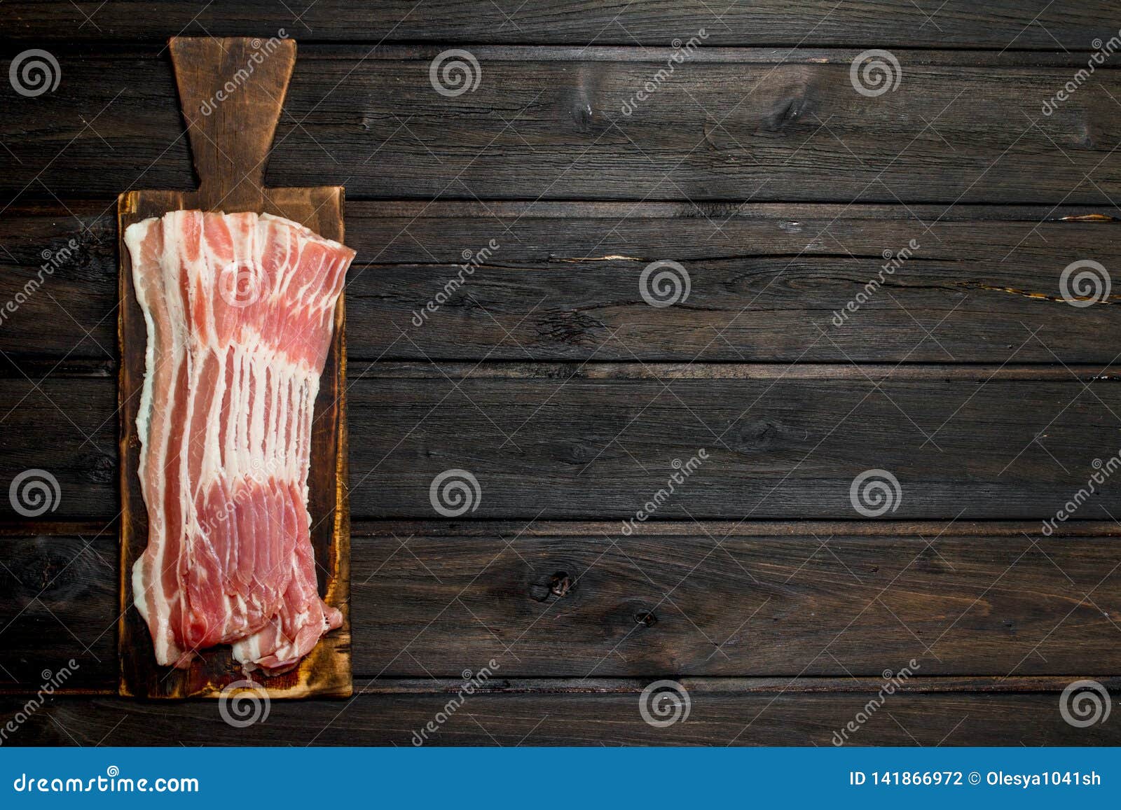 Raw bacon on an old Board stock photo. Image of product - 141866972