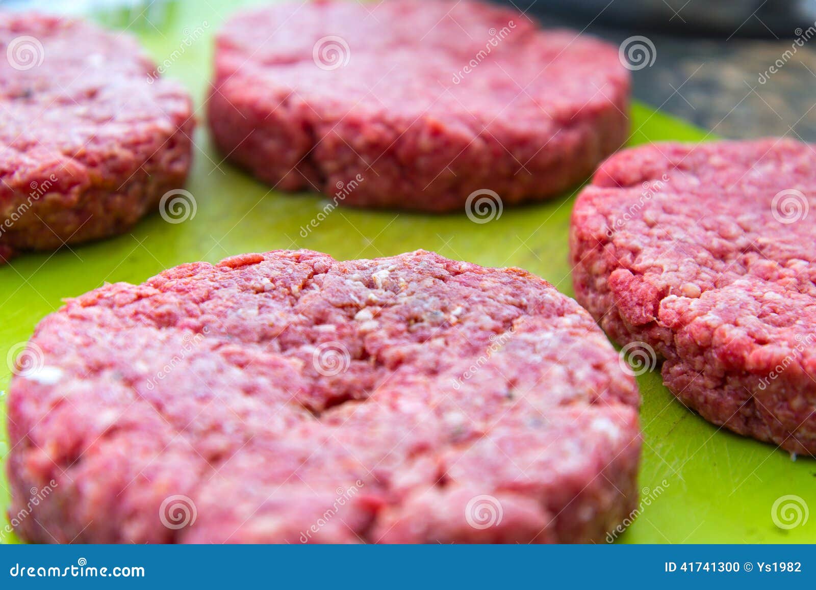 Raw Beef Burgers Close Up on a Chopping Board Stock Photo - Image of ...