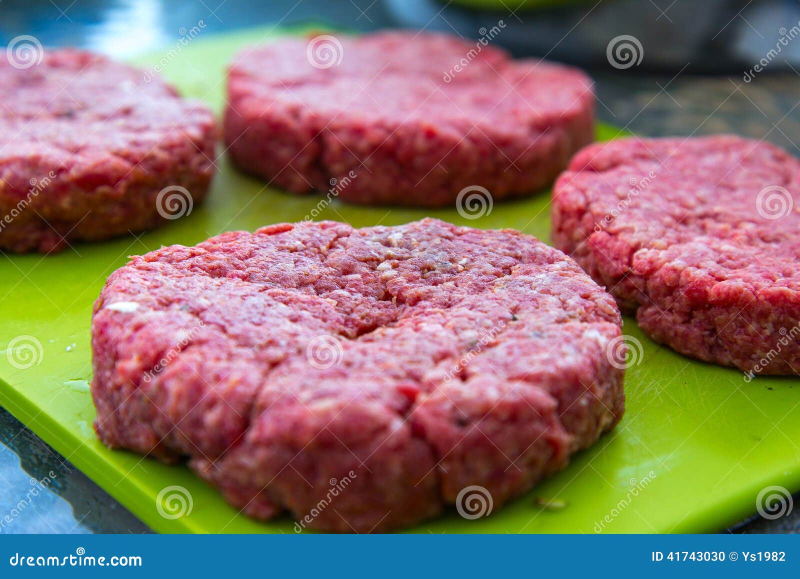 Raw Beef Burgers Close Up on a Chopping Board Stock Photo - Image of ...