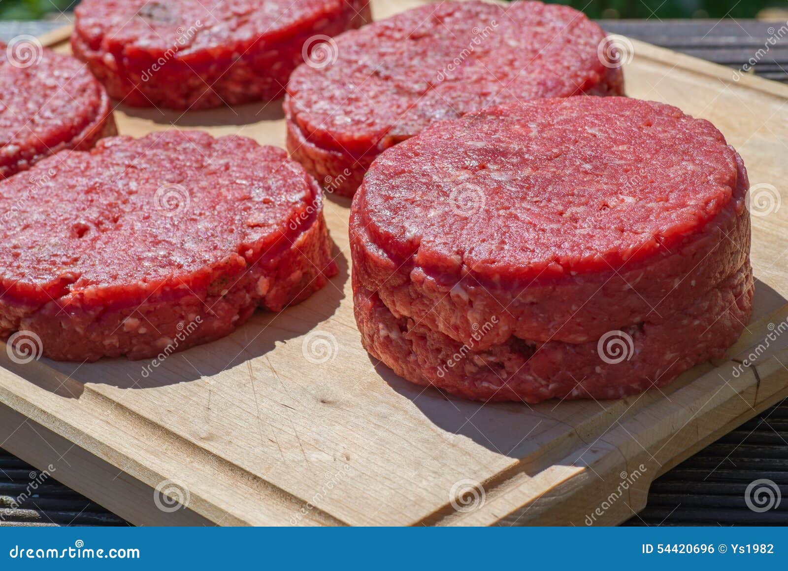 Raw Beef Burgers Close Up on a Chopping Board Stock Photo - Image of ...
