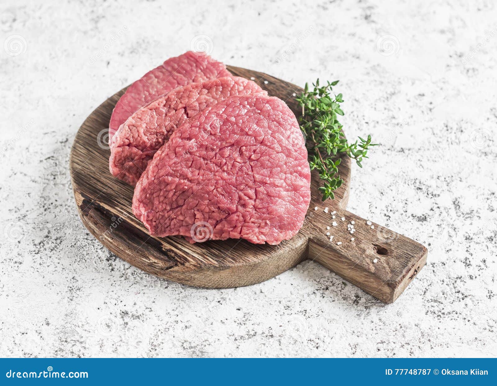 Raw Beef Chops and Fresh Thyme on a Wooden Cutting Board Stock Image ...
