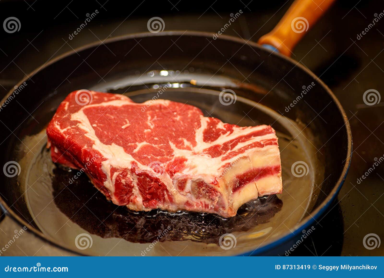 Raw Beef Loin on the Bone , Fried in a Skillet. Stock Image - Image of ...