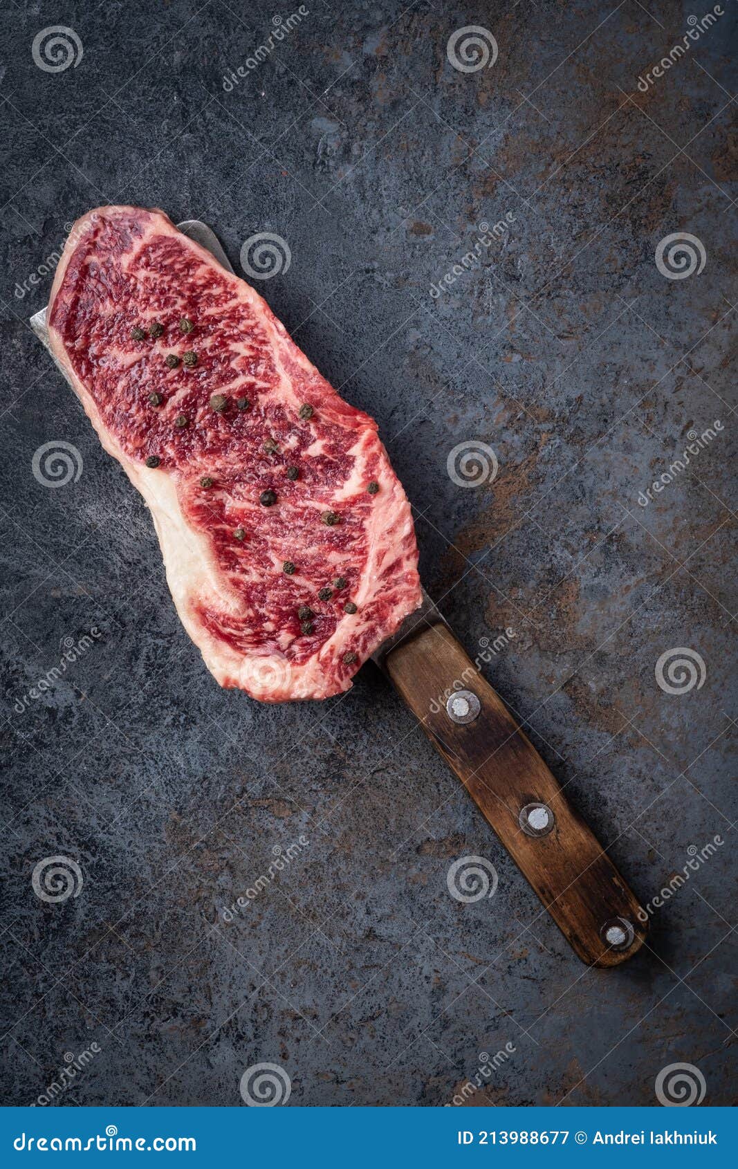 Raw Beef Steak on a Meat Cleaver on a Dark Stone Table Stock Image ...