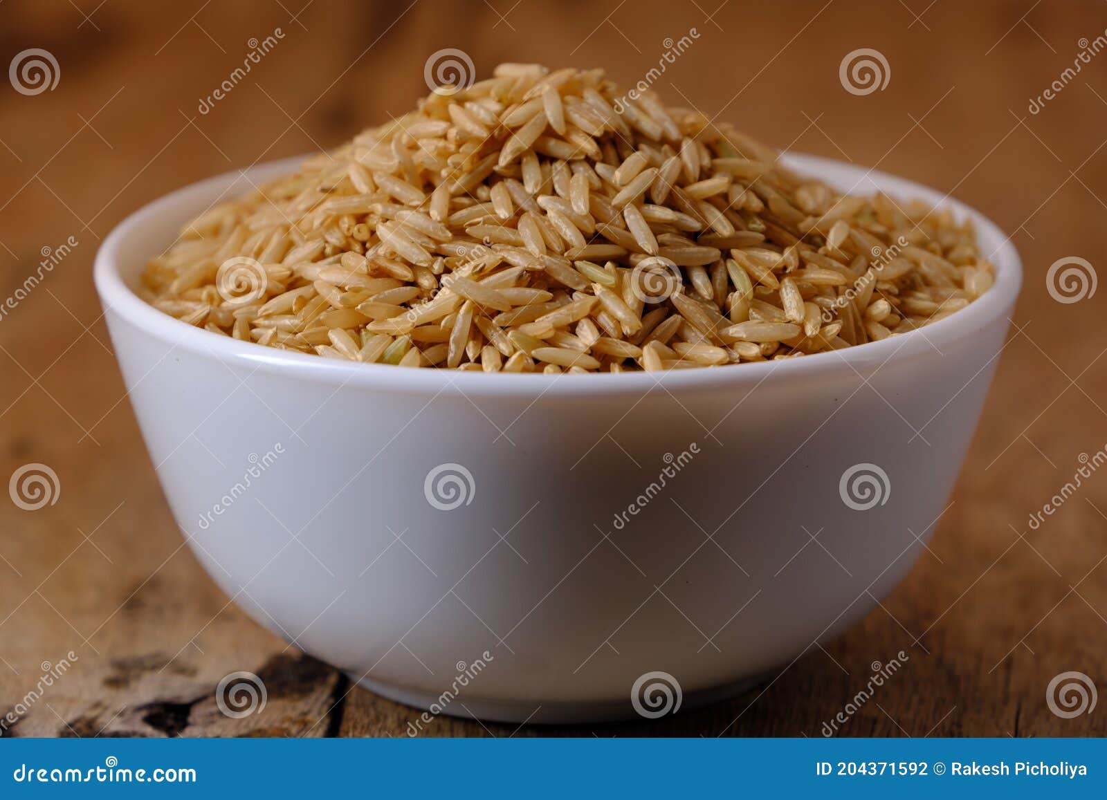 Raw brown rice in a bowl stock photo. Image of grained - 204371592