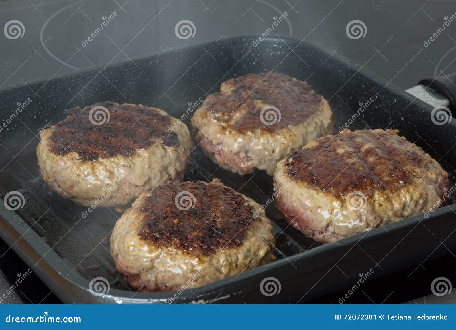 Raw Burgers, Beef in a Frying Pan on Cooking Surface in Kitchen Stock ...