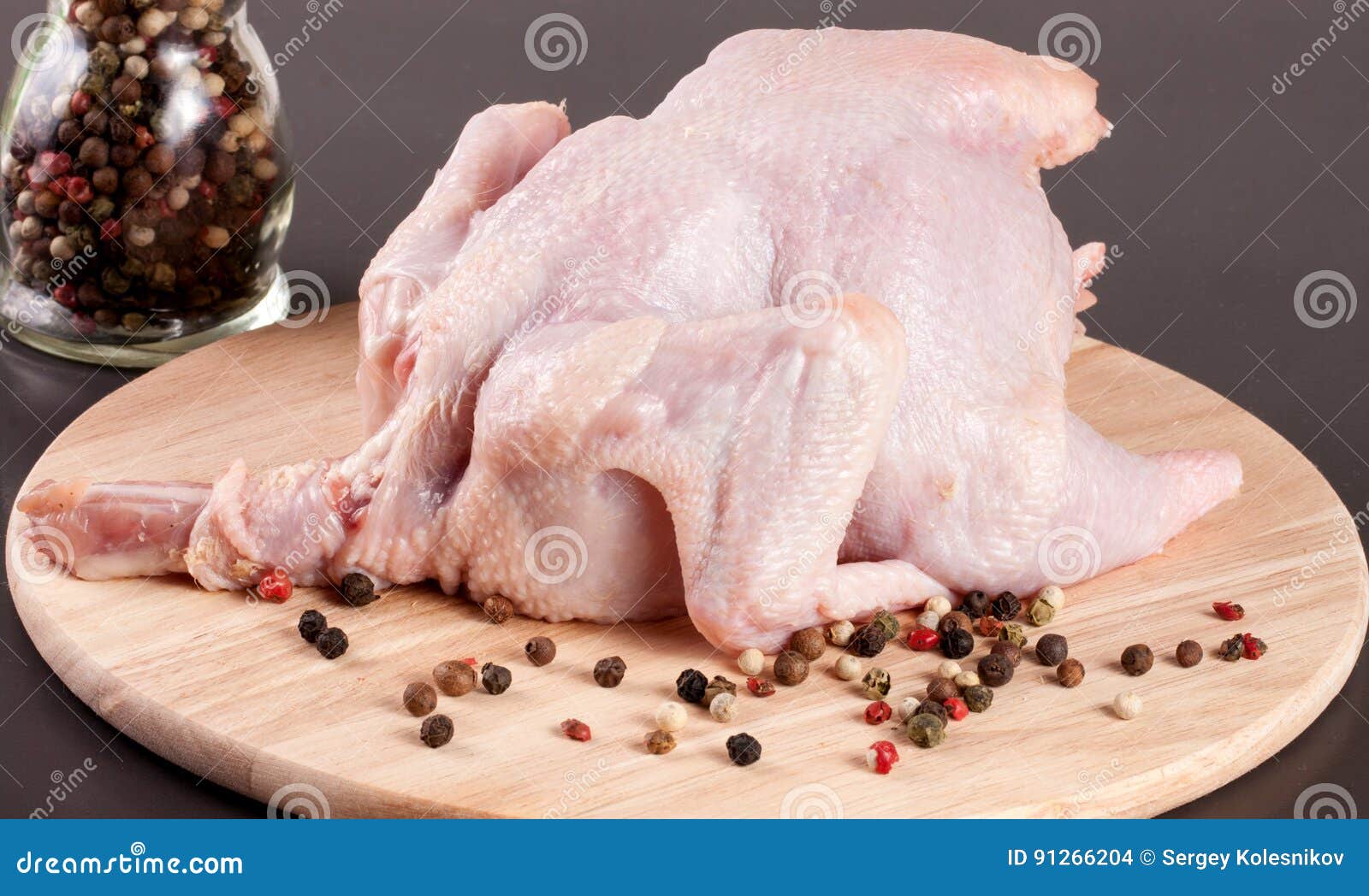 Raw Chicken Carcass with Peppercorns on a Dark Background Stock Photo ...