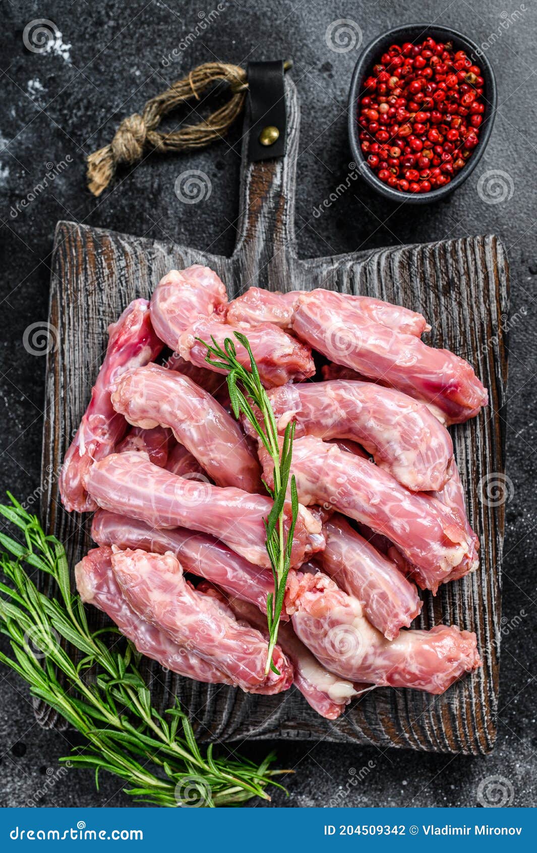 Raw Chicken Neck Meat on a Cutting Board. Black Background Stock Photo ...